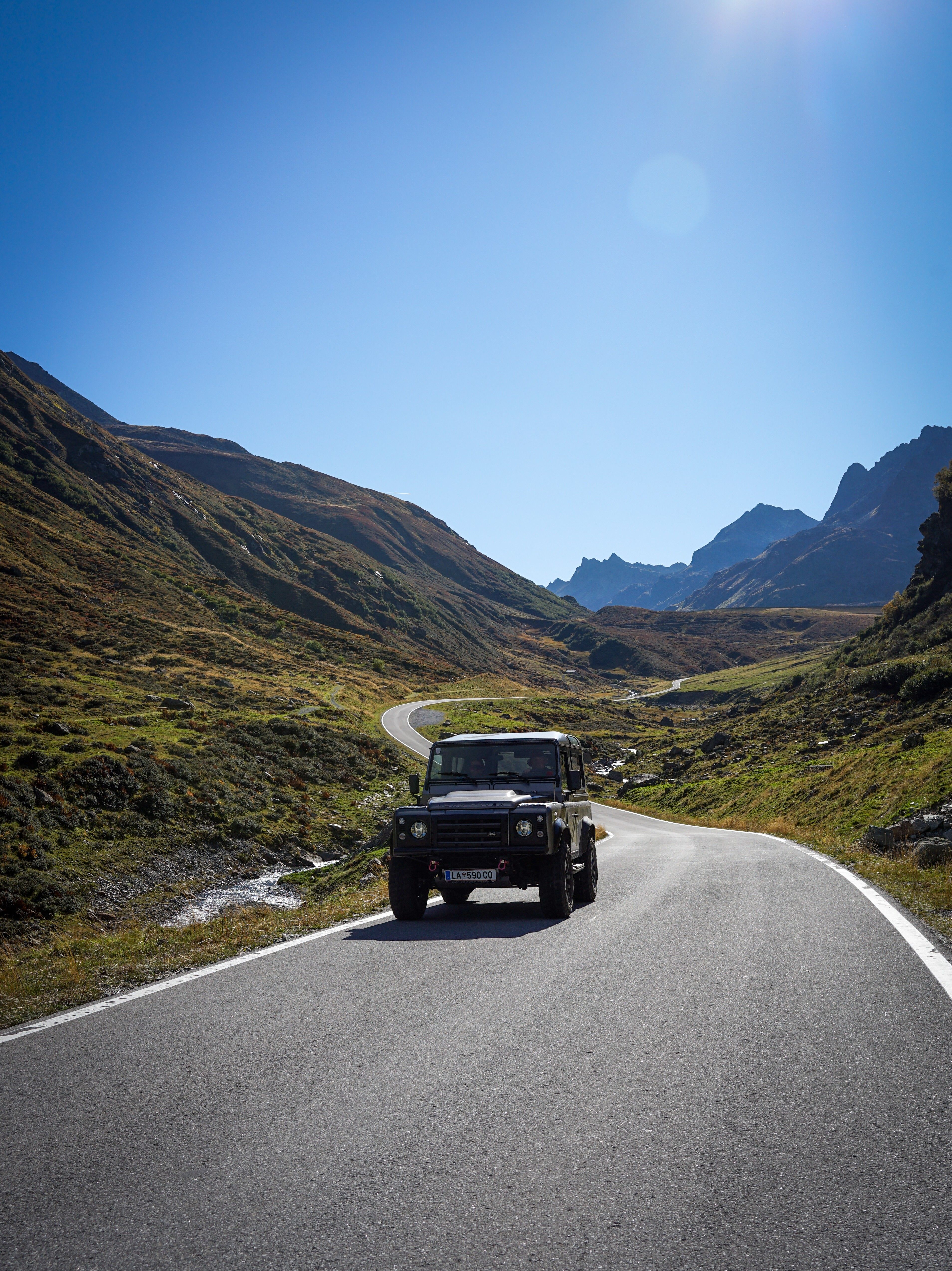 Off-road vehicle on a scenic mountain road · Free Stock Photo