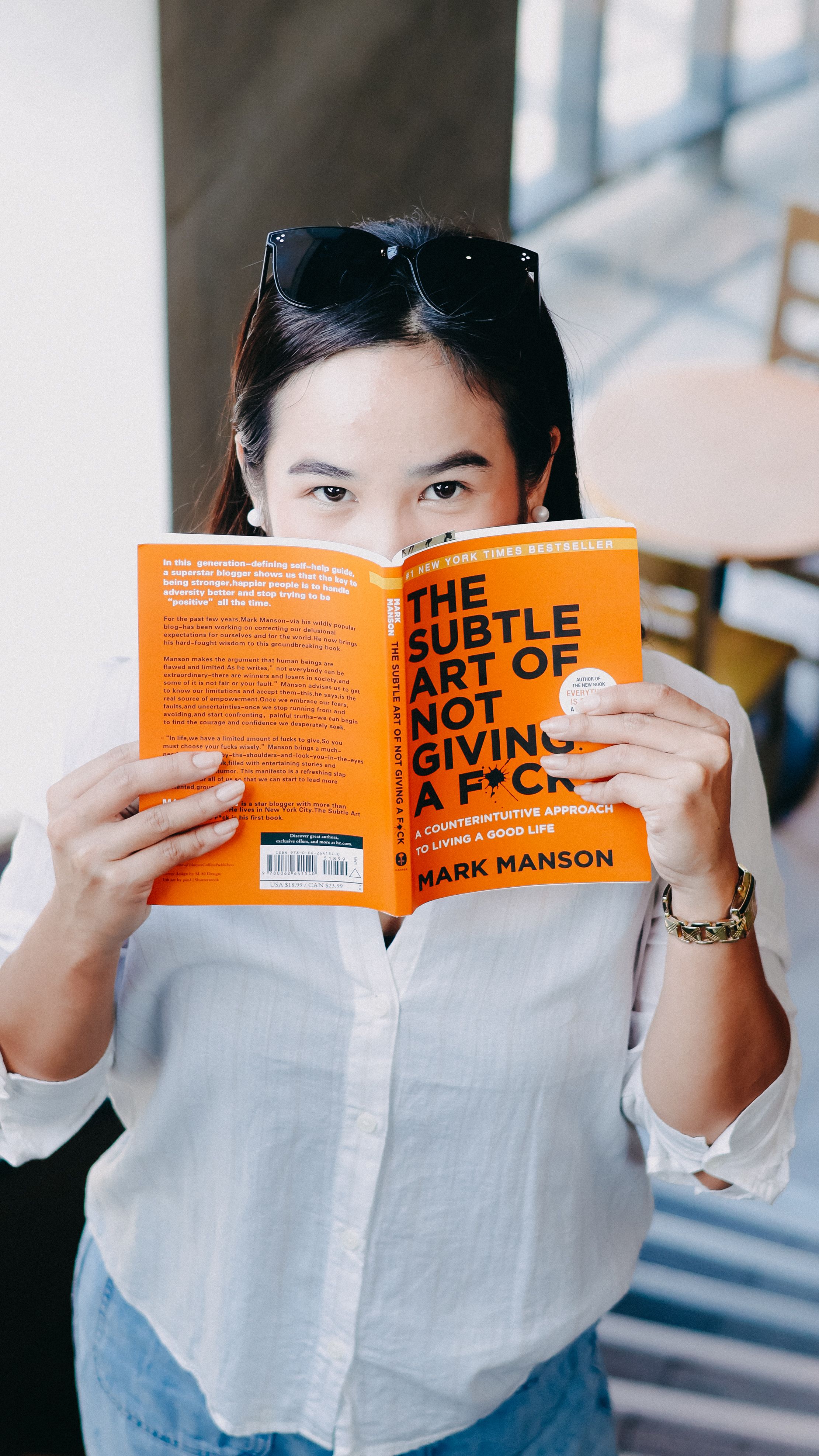 Woman Reading 'The Subtle Art' by Mark Manson · Free Stock Photo