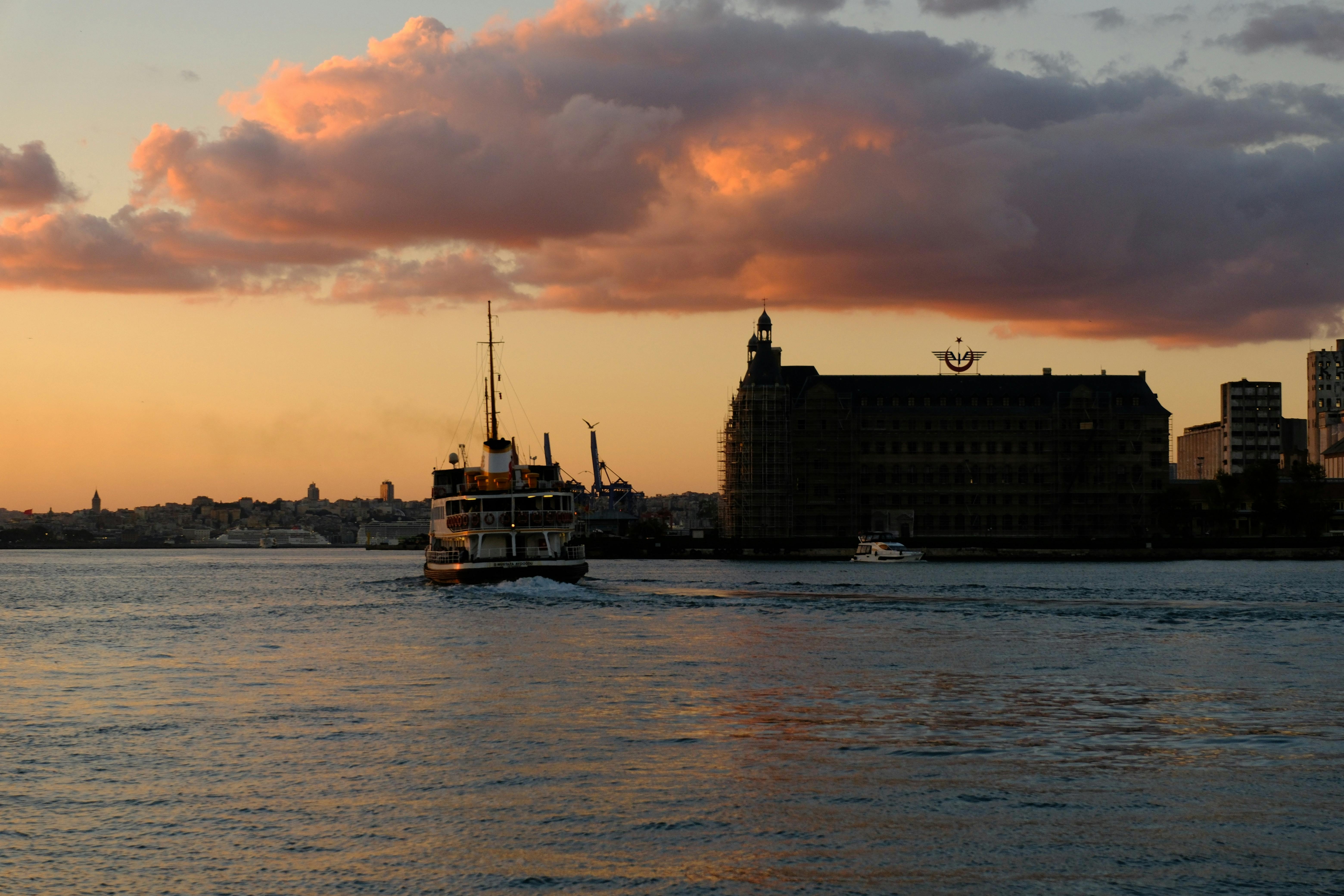 Sunset Over Scenic Istanbul Waterway with Ferry · Free Stock Photo