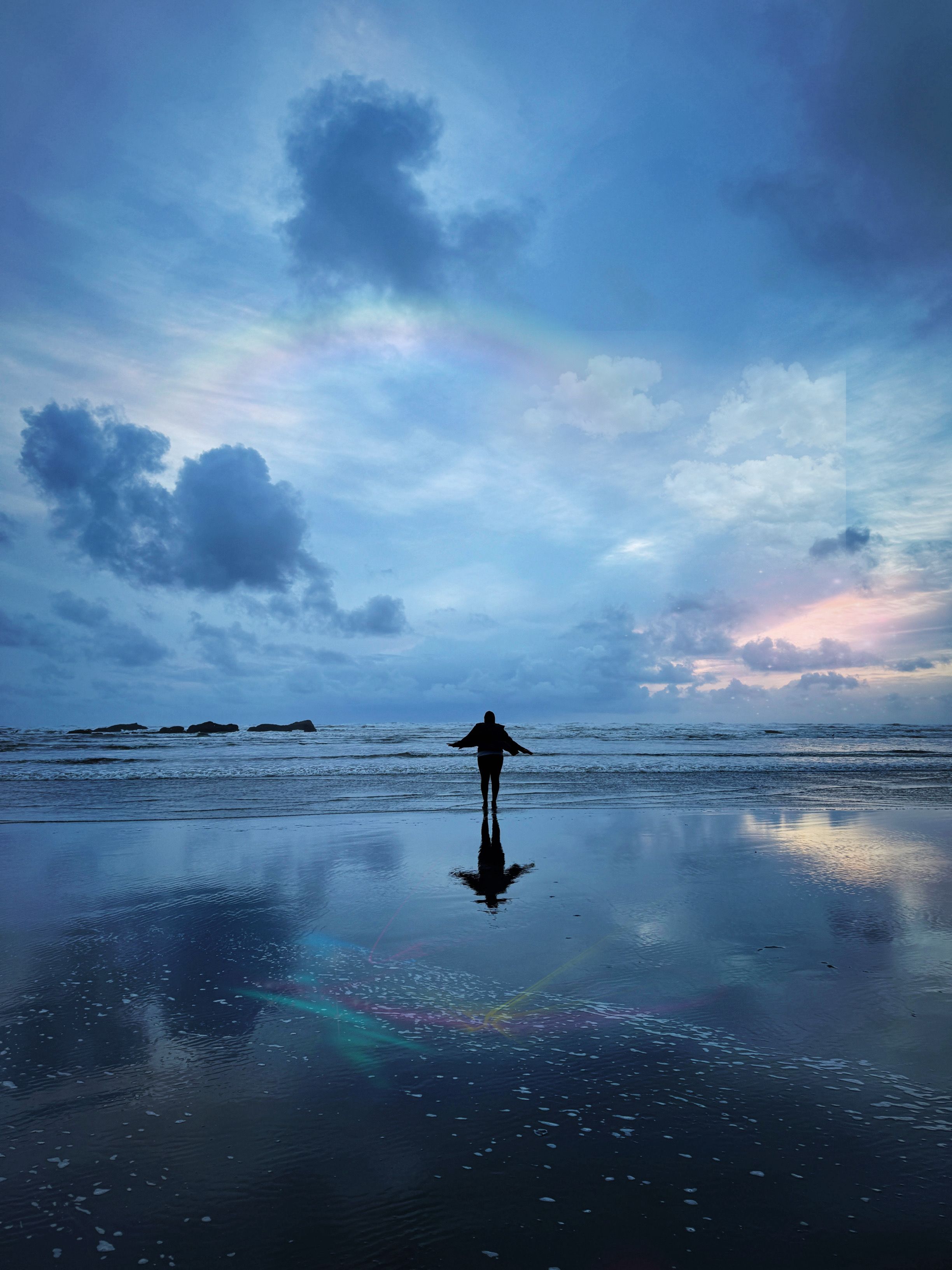 Silhouette of Person Facing Ocean at Dusk · Free Stock Photo