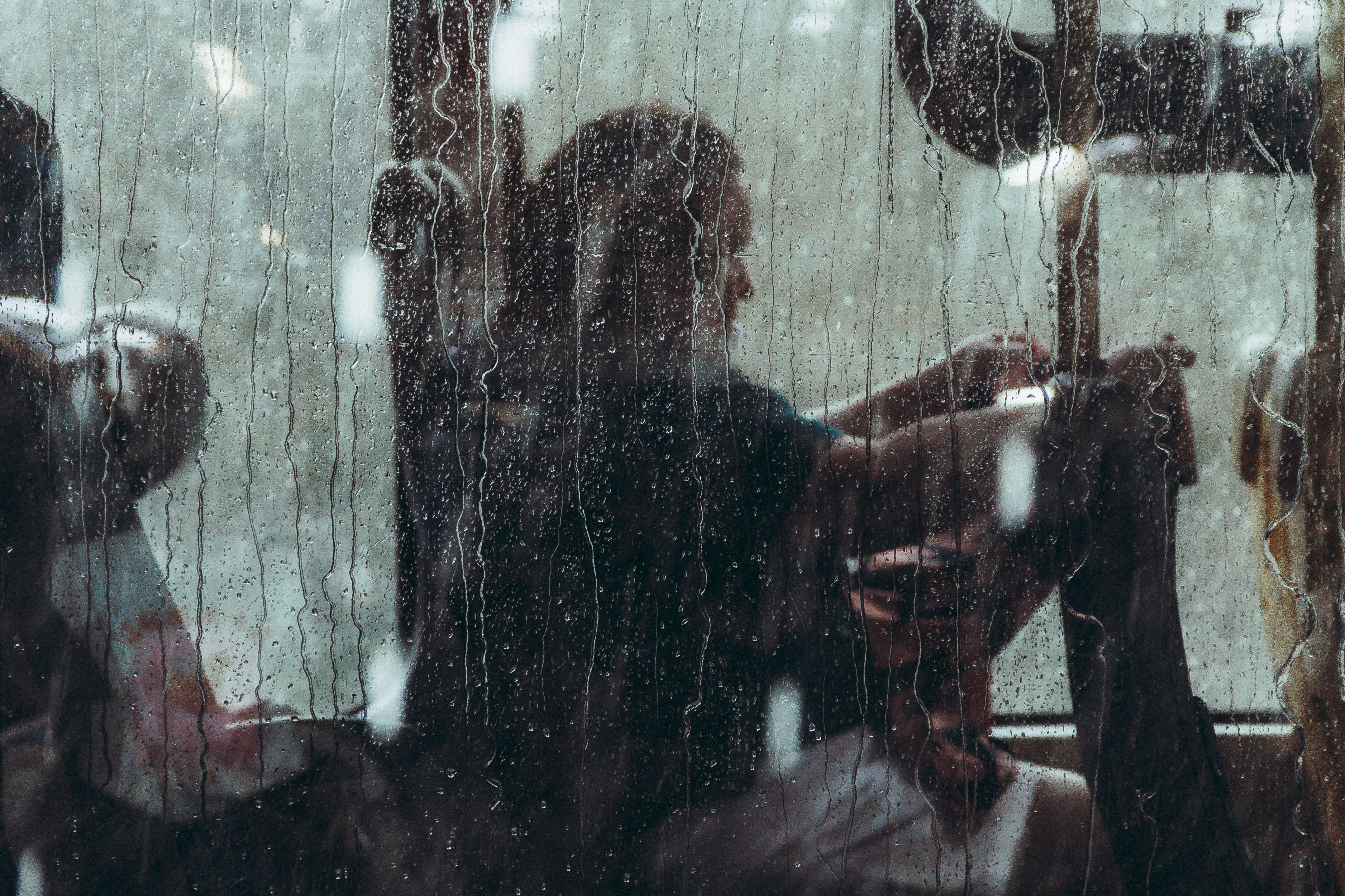 Silhouette of Person Through Rainy Bus Window · Free Stock Photo