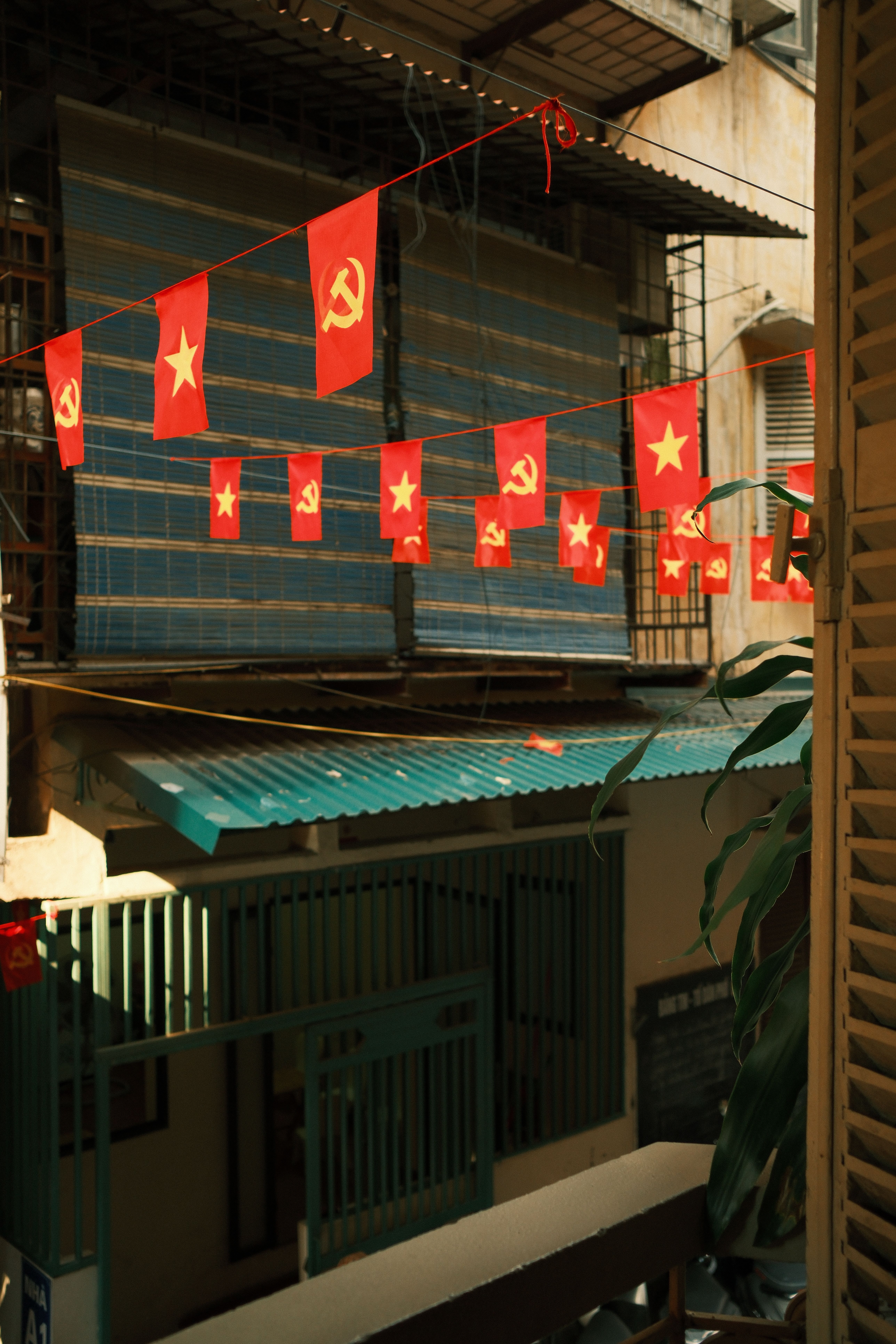 Communist Flags Hanging Outdoors in Urban Setting · Free Stock Photo