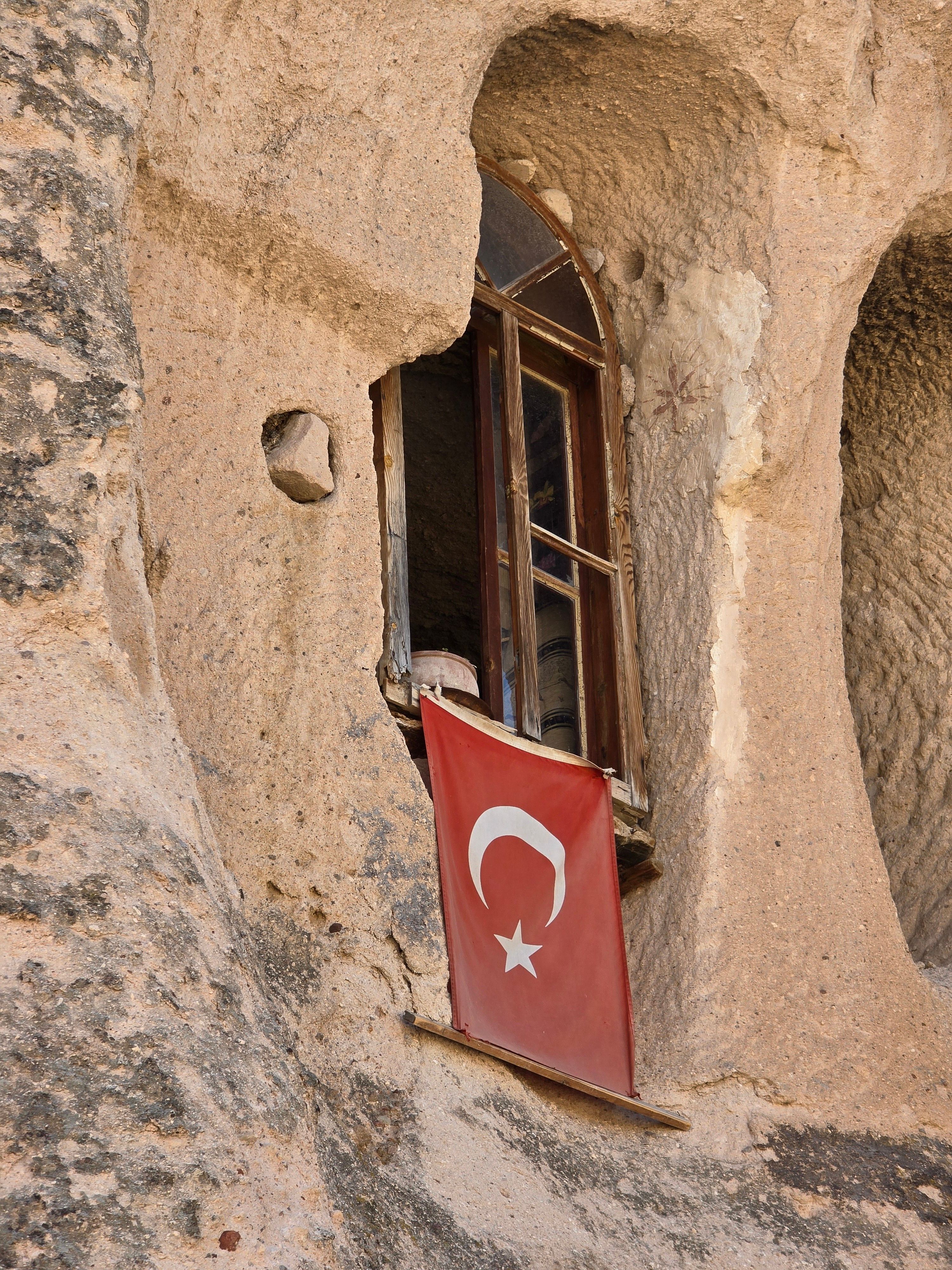 Cappadocia Cave Dwelling with Turkish Flag · Free Stock Photo
