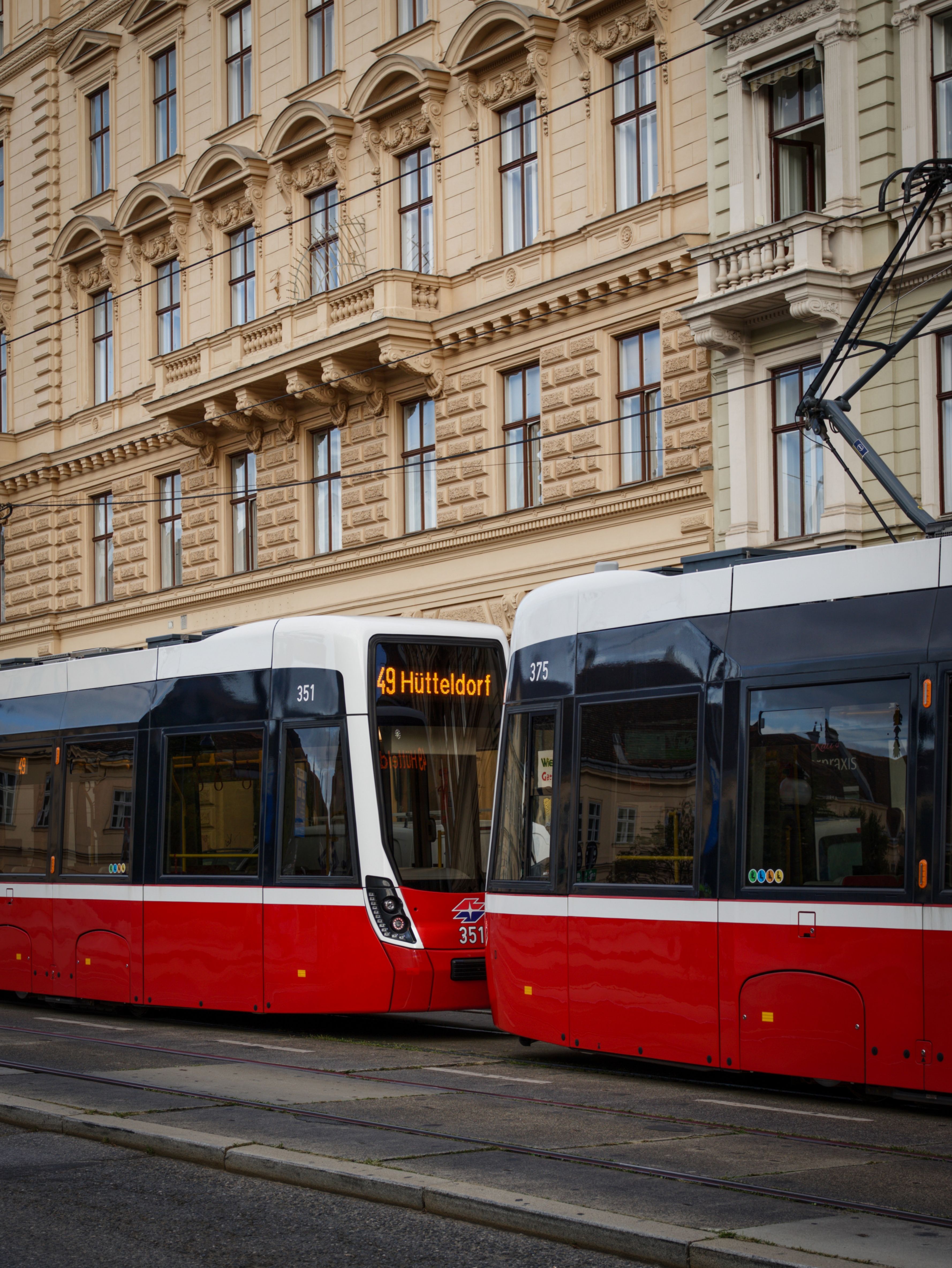 Red and White Trams in Vienna Cityscape · Free Stock Photo