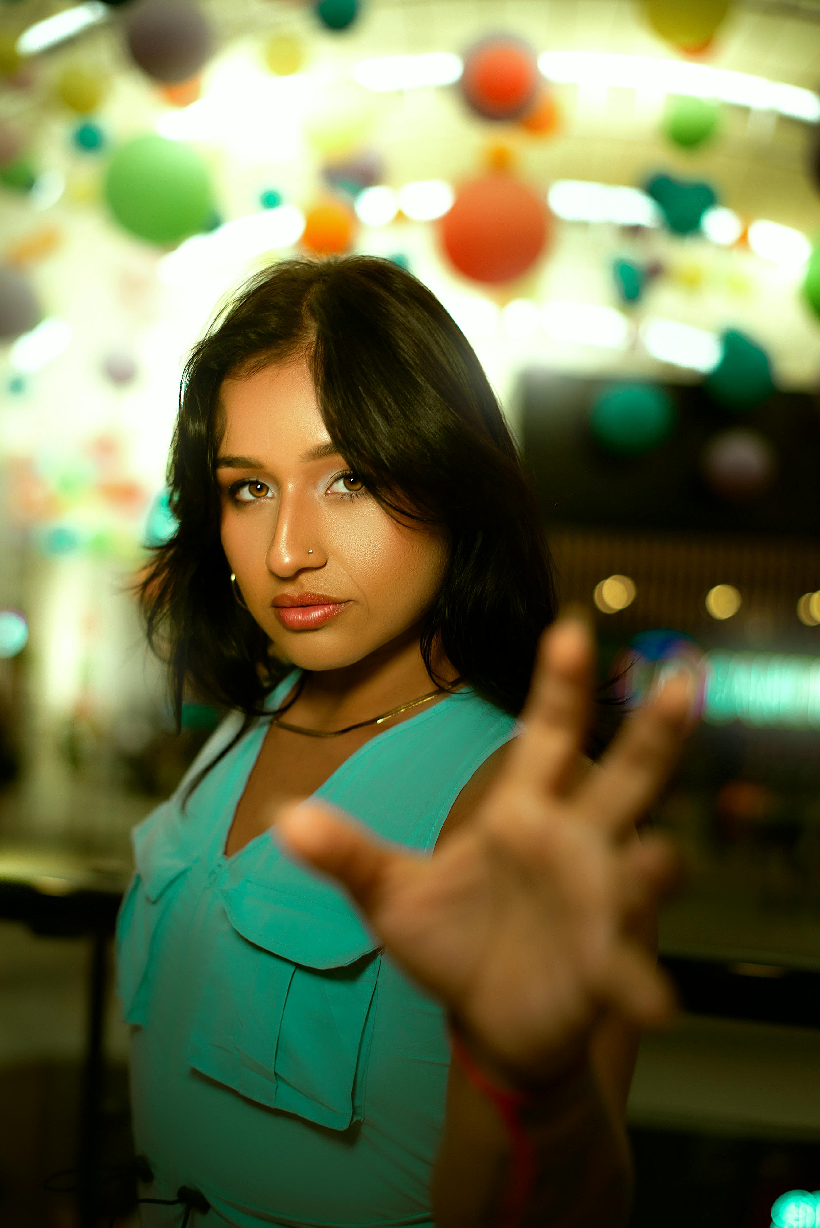Portrait of a Woman Reaching Out in Colorful Setting · Free Stock Photo