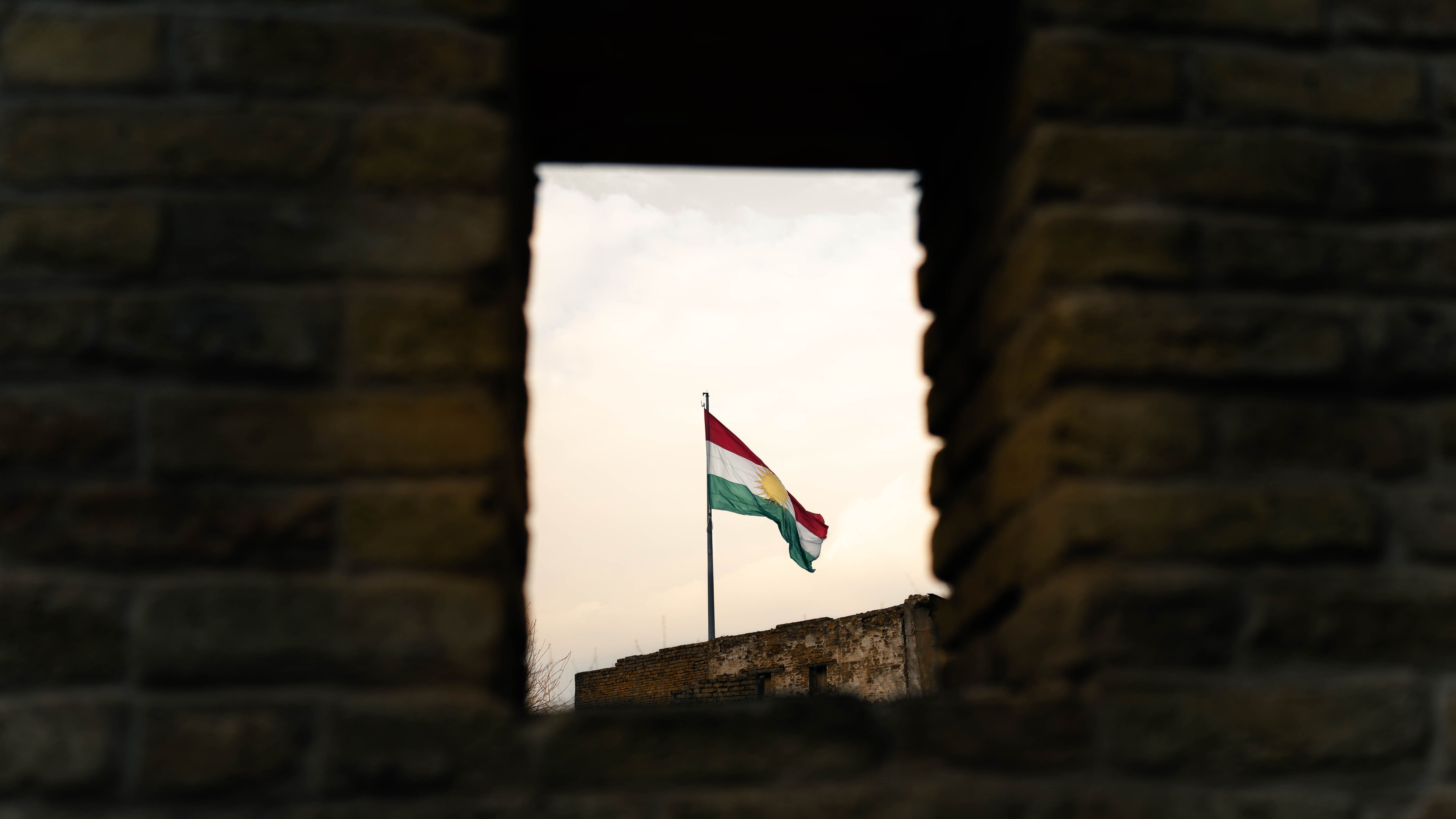 Kurdistan Flag through Erbil Citadel Wall · Free Stock Photo