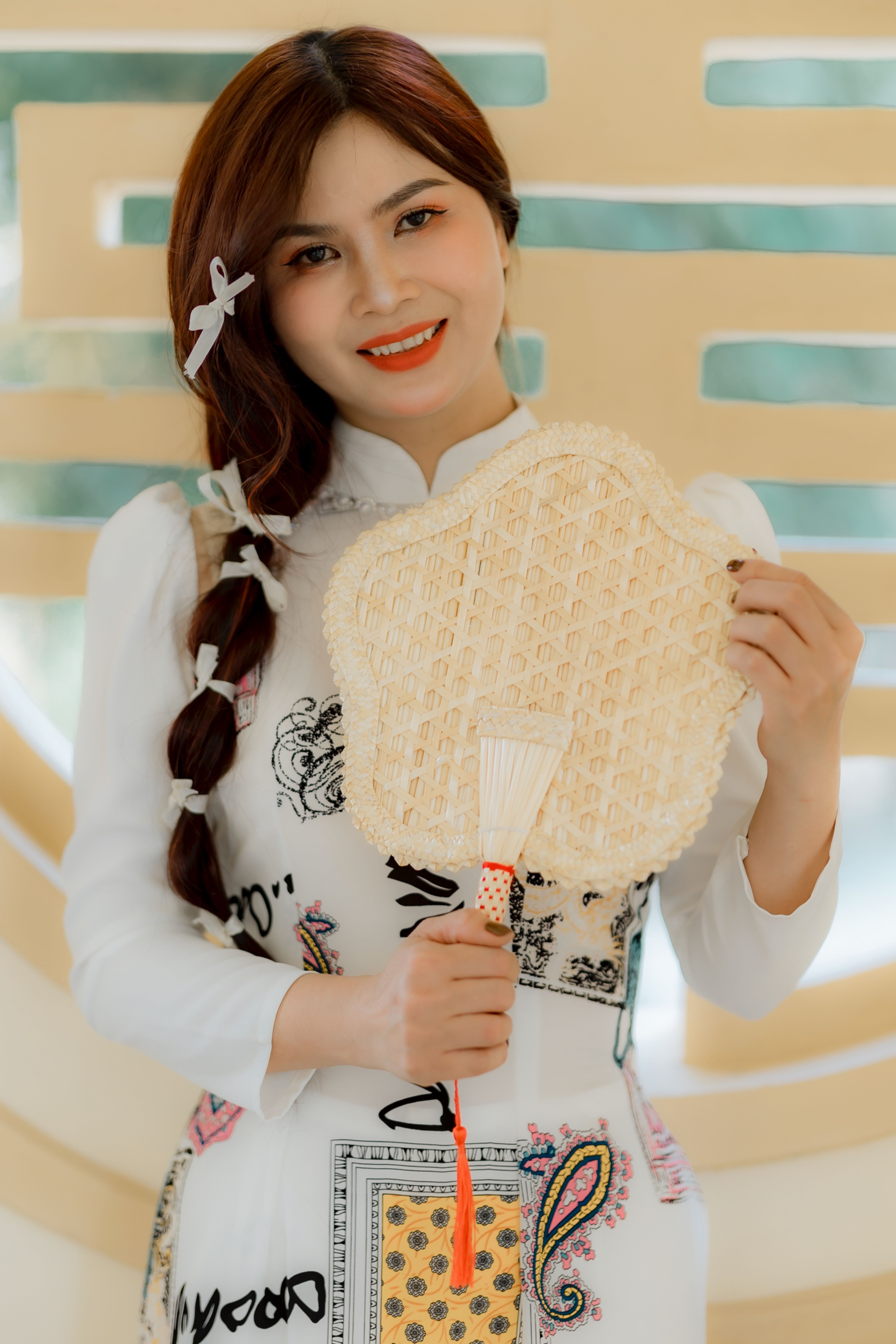 Woman in Traditional Dress Holding a Hand Fan · Free Stock Photo