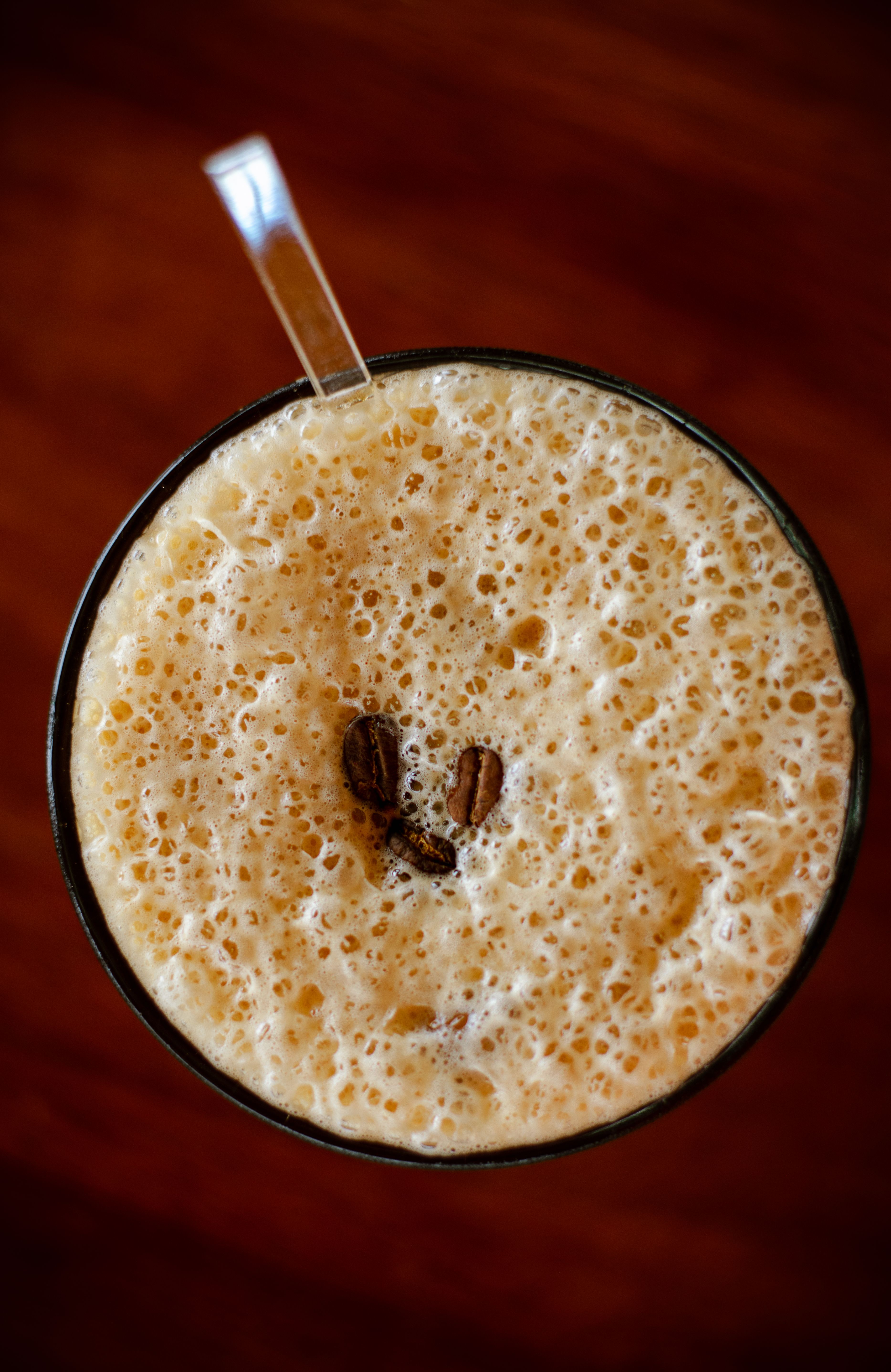 Overhead View of Frothy Coffee with Beans · Free Stock Photo