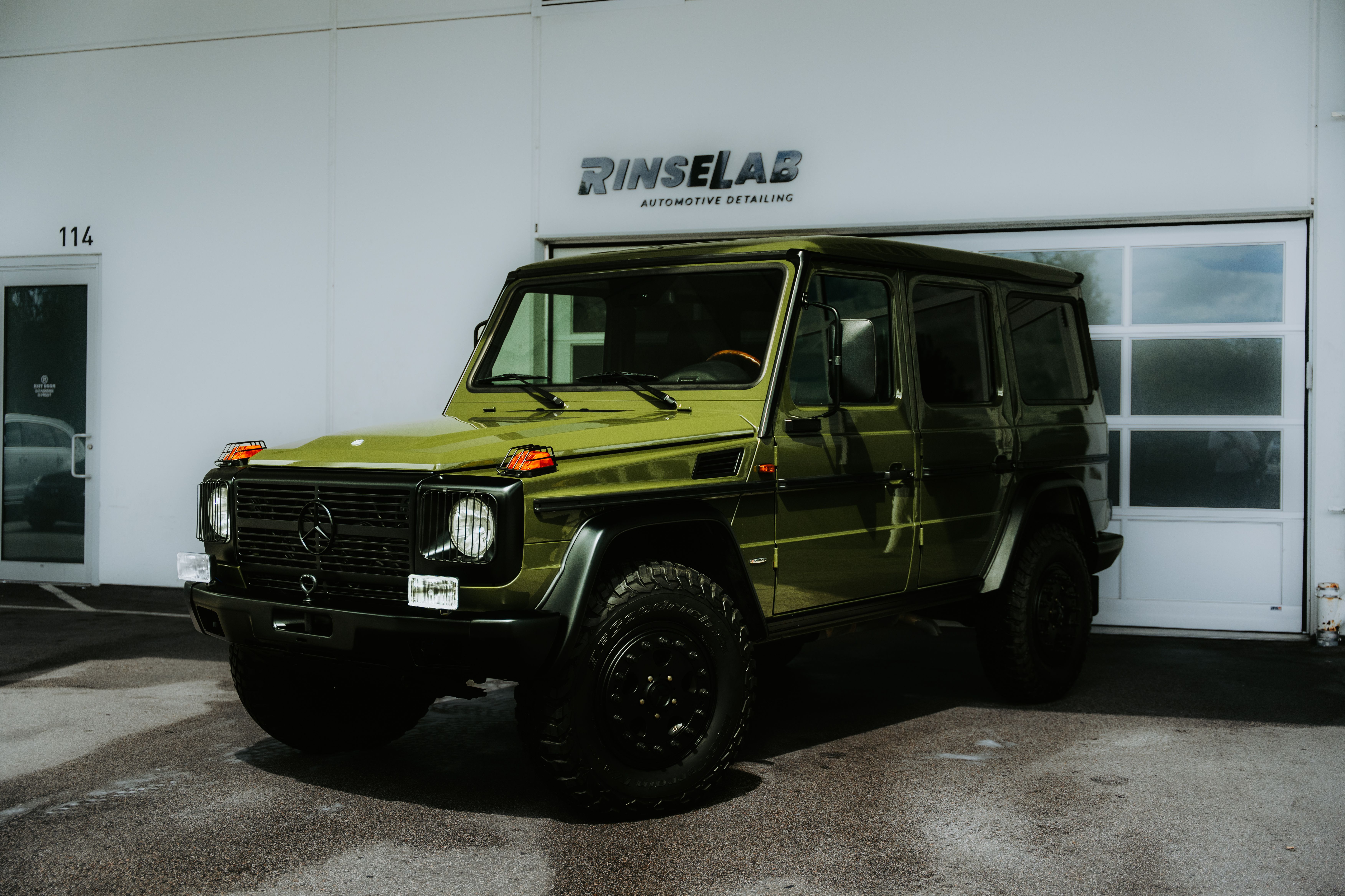 Green Off-Road SUV at Automotive Detailing Shop · Free Stock Photo