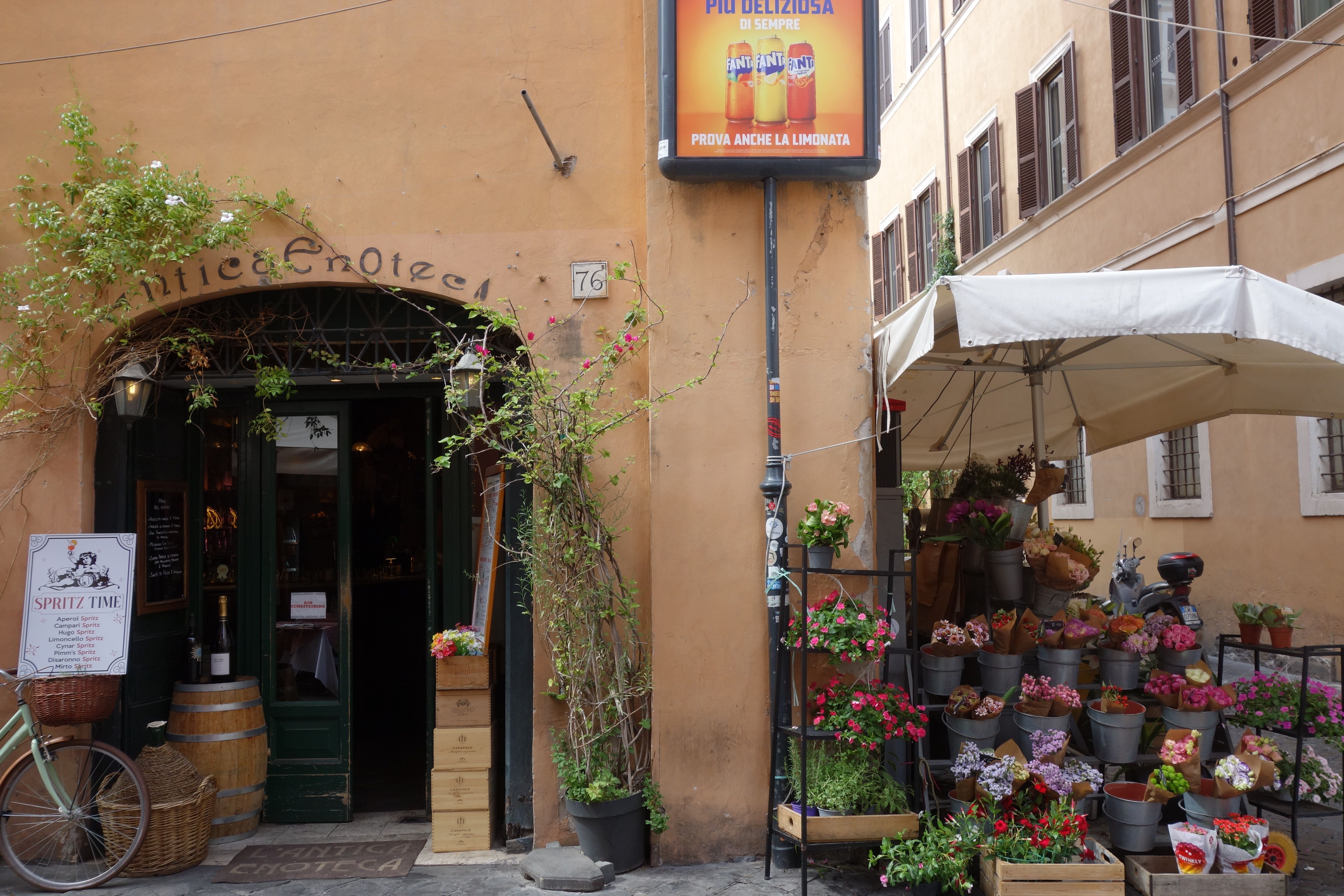 Charming Italian Flower Shop and Enoteca Street Scene · Free Stock Photo