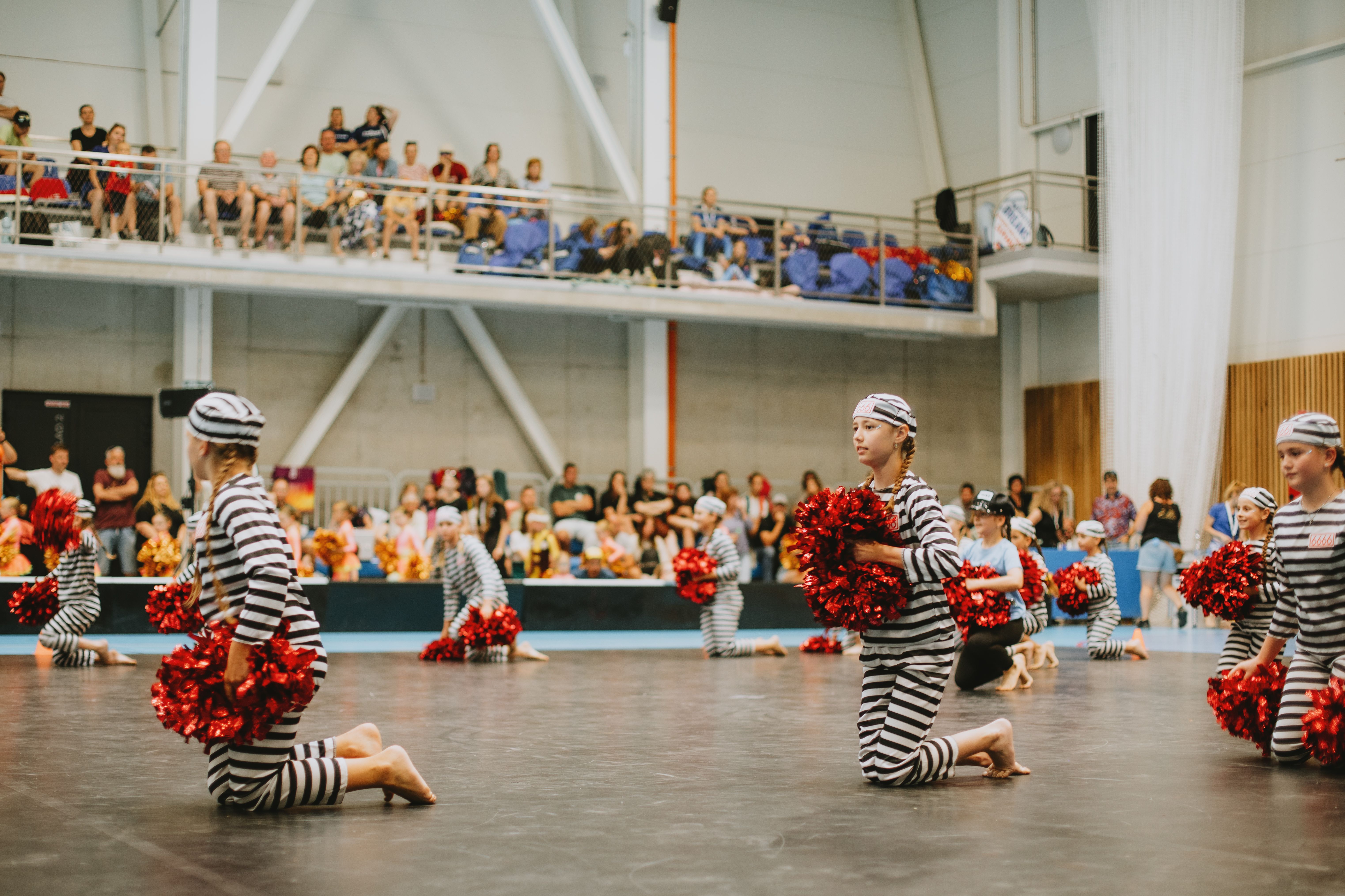Cheerleading Performance in Prisoner Costumes · Free Stock Photo