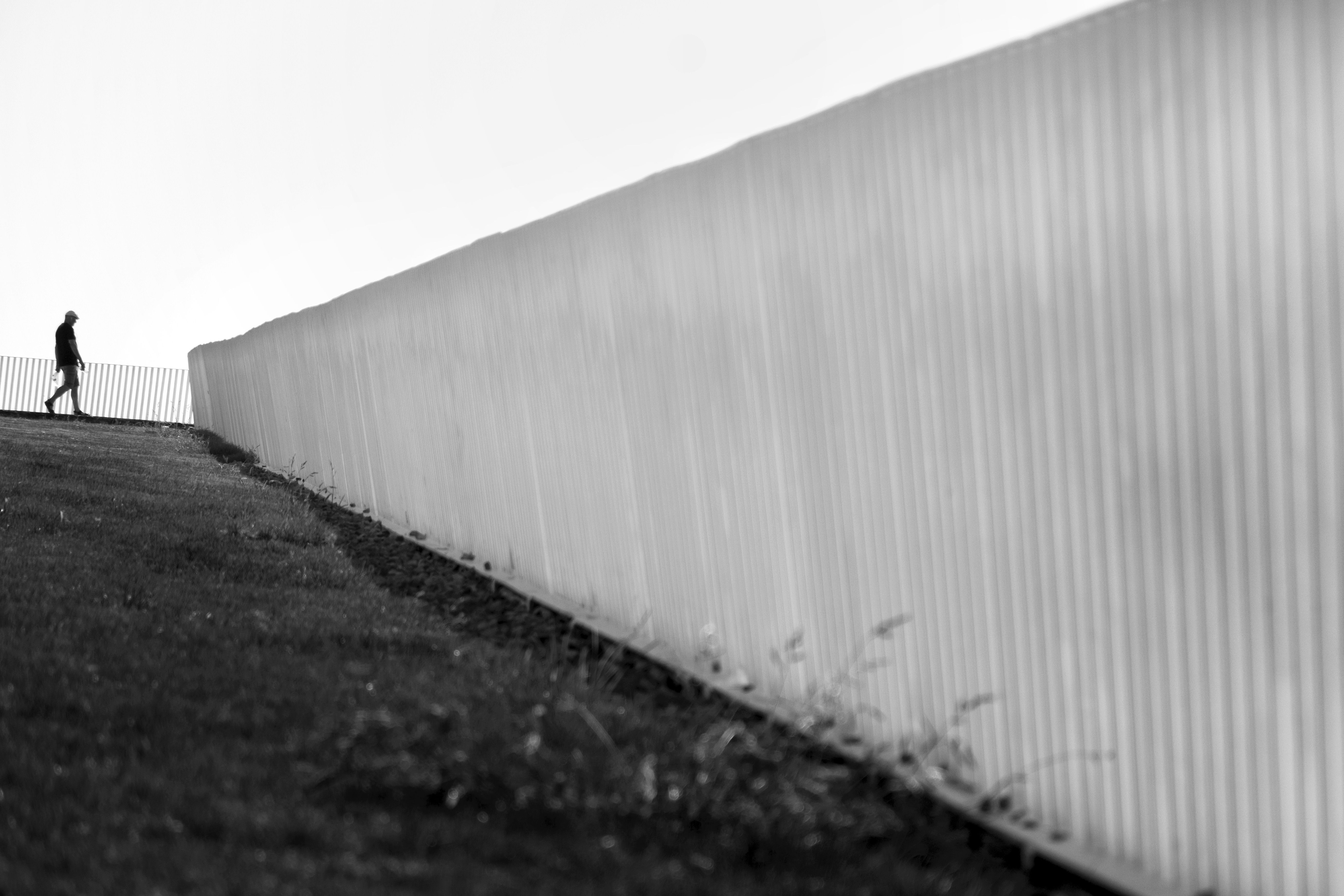 Lonely Figure Walking Along a Sloped Path · Free Stock Photo