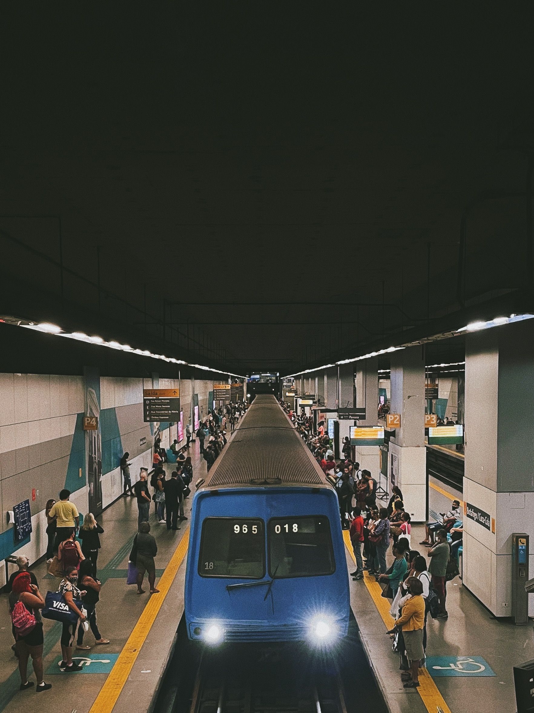 Busy Urban Subway Station with Blue Train · Free Stock Photo