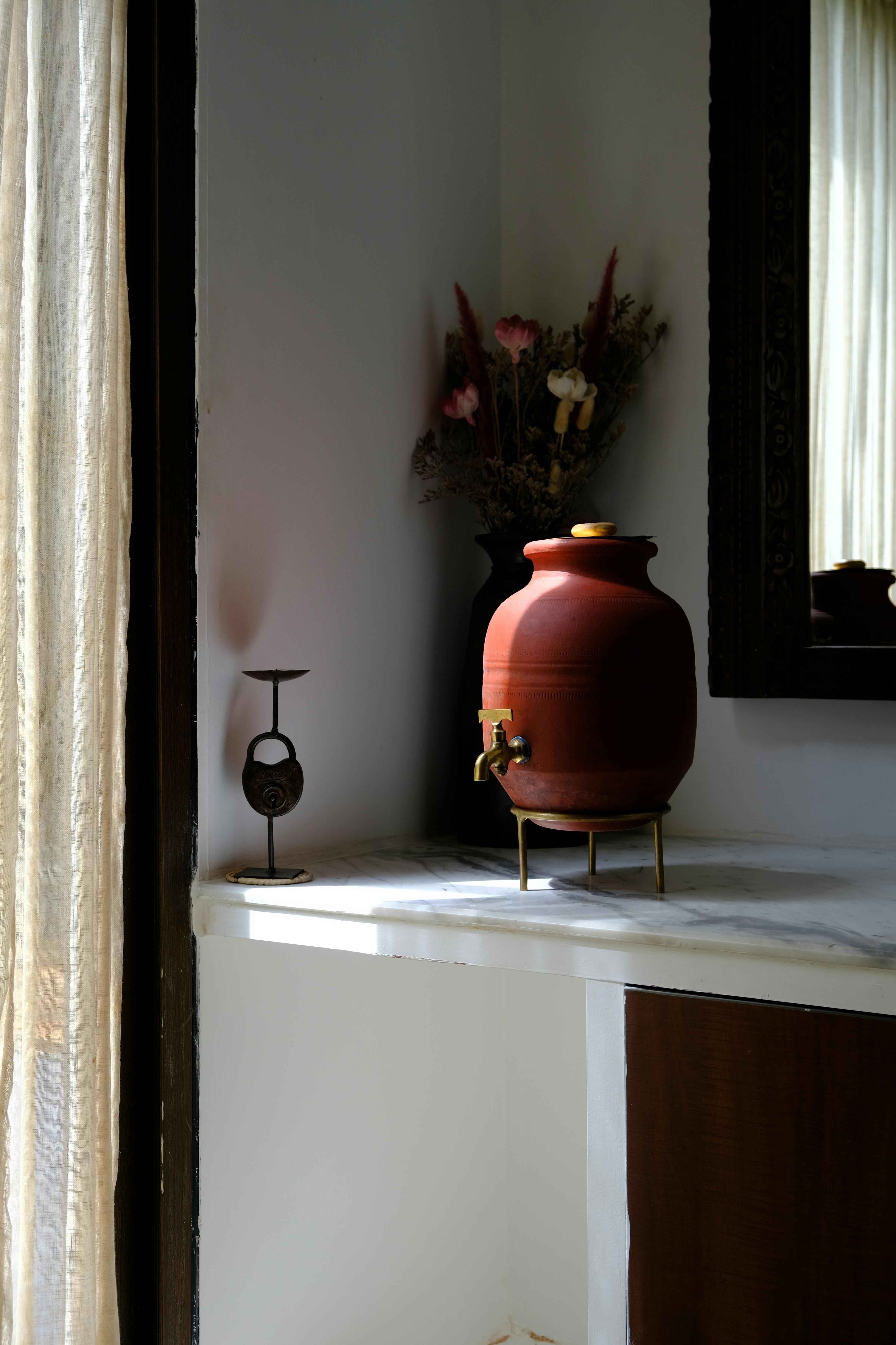 Rustic Terracotta Water Pitcher on Marble Ledge · Free Stock Photo
