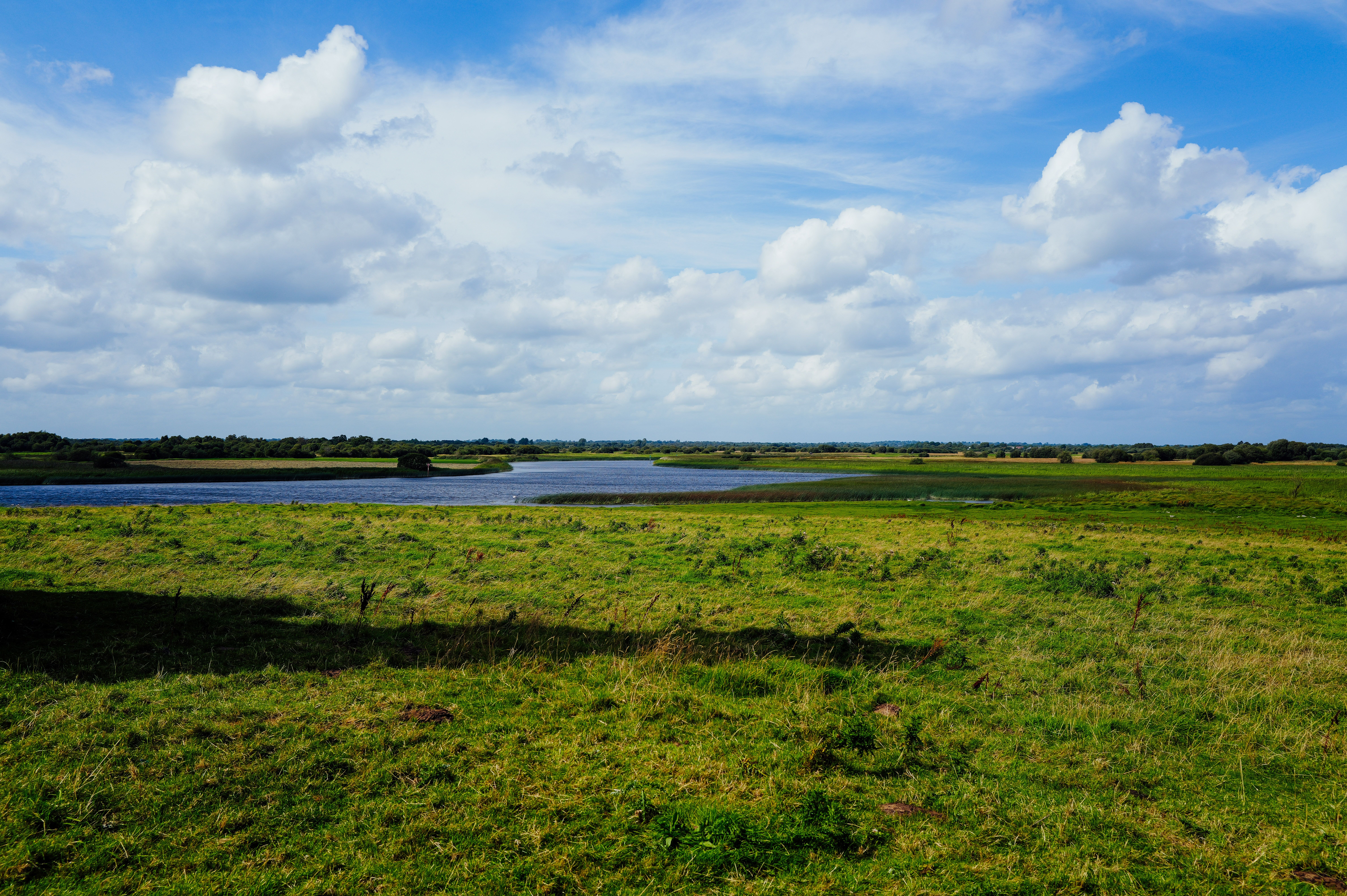 Scenic Pastoral Landscape with River and Blue Sky · Free Stock Photo