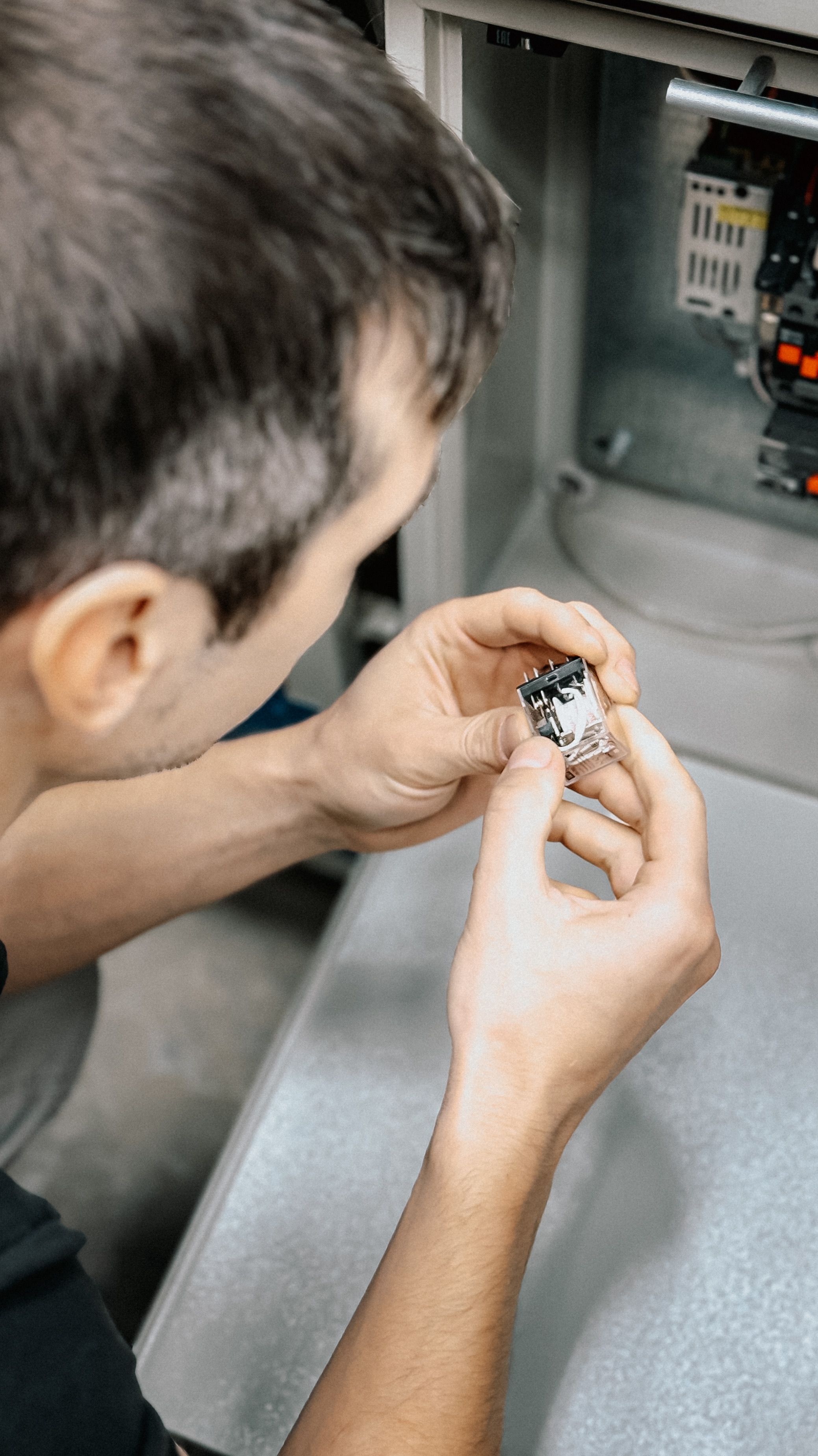Technician Inspecting Electronic Component · Free Stock Photo