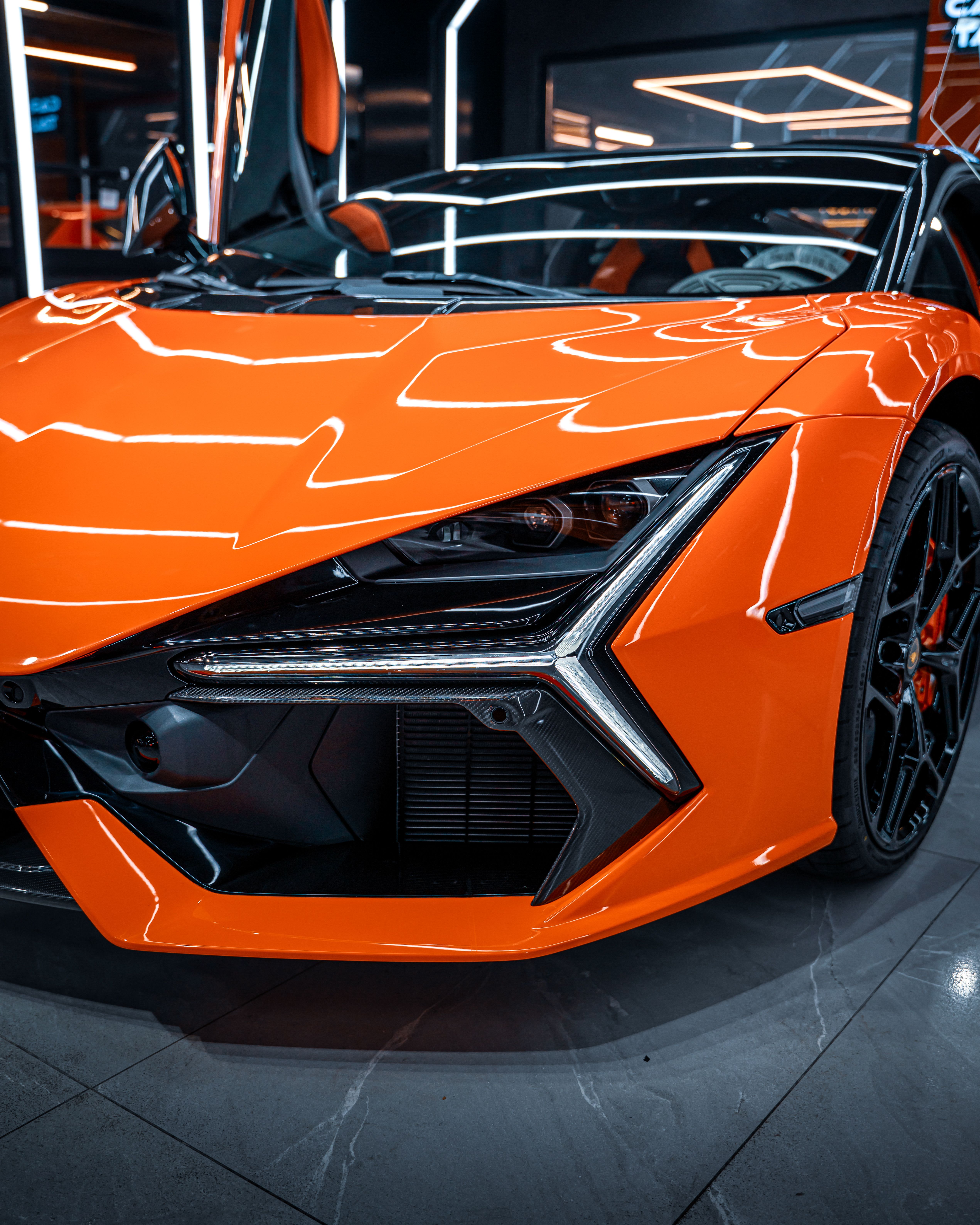 Sleek Orange Sports Car Display in Ankara Showroom · Free Stock Photo