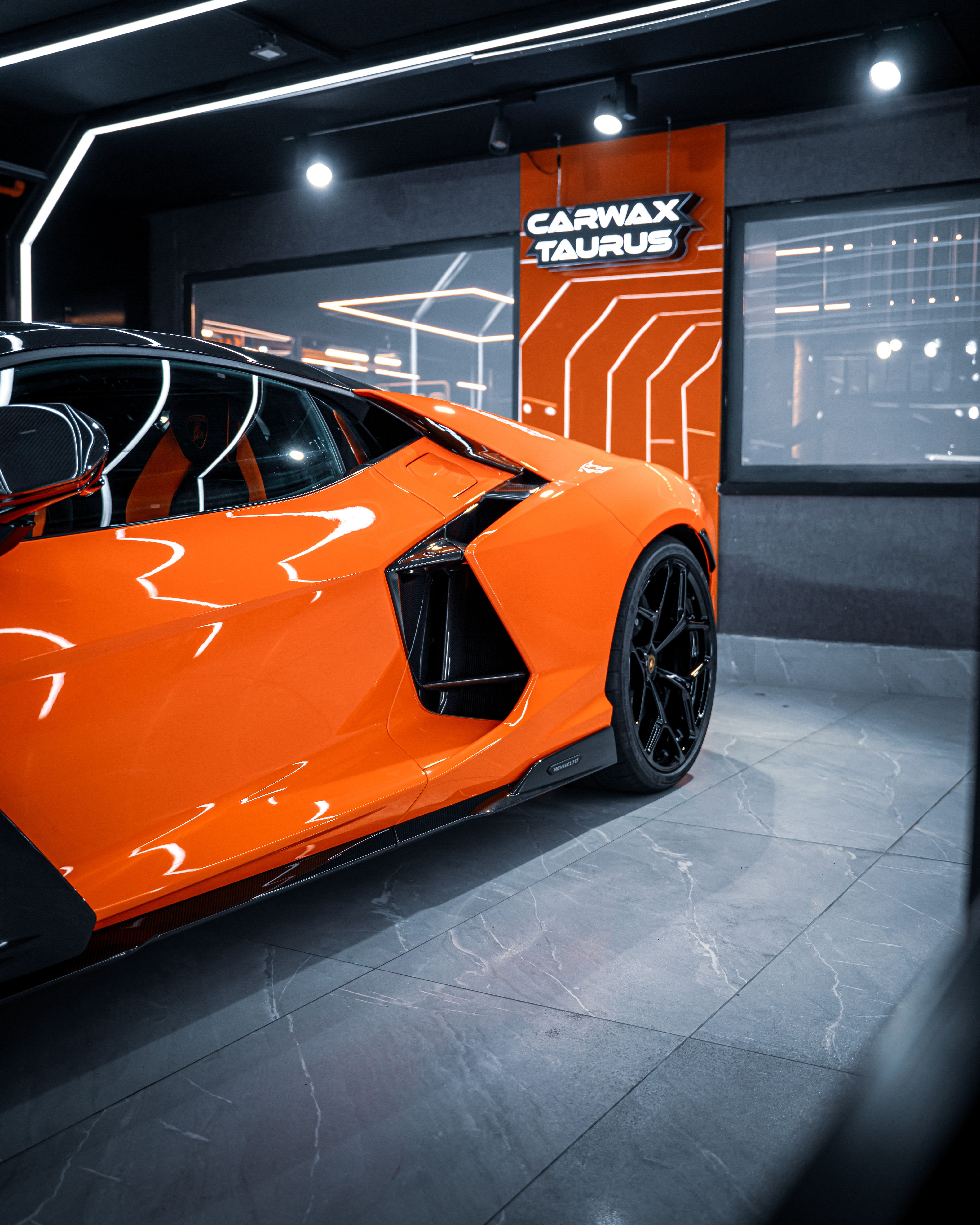 Sleek Orange Sports Car in Ankara Showroom · Free Stock Photo