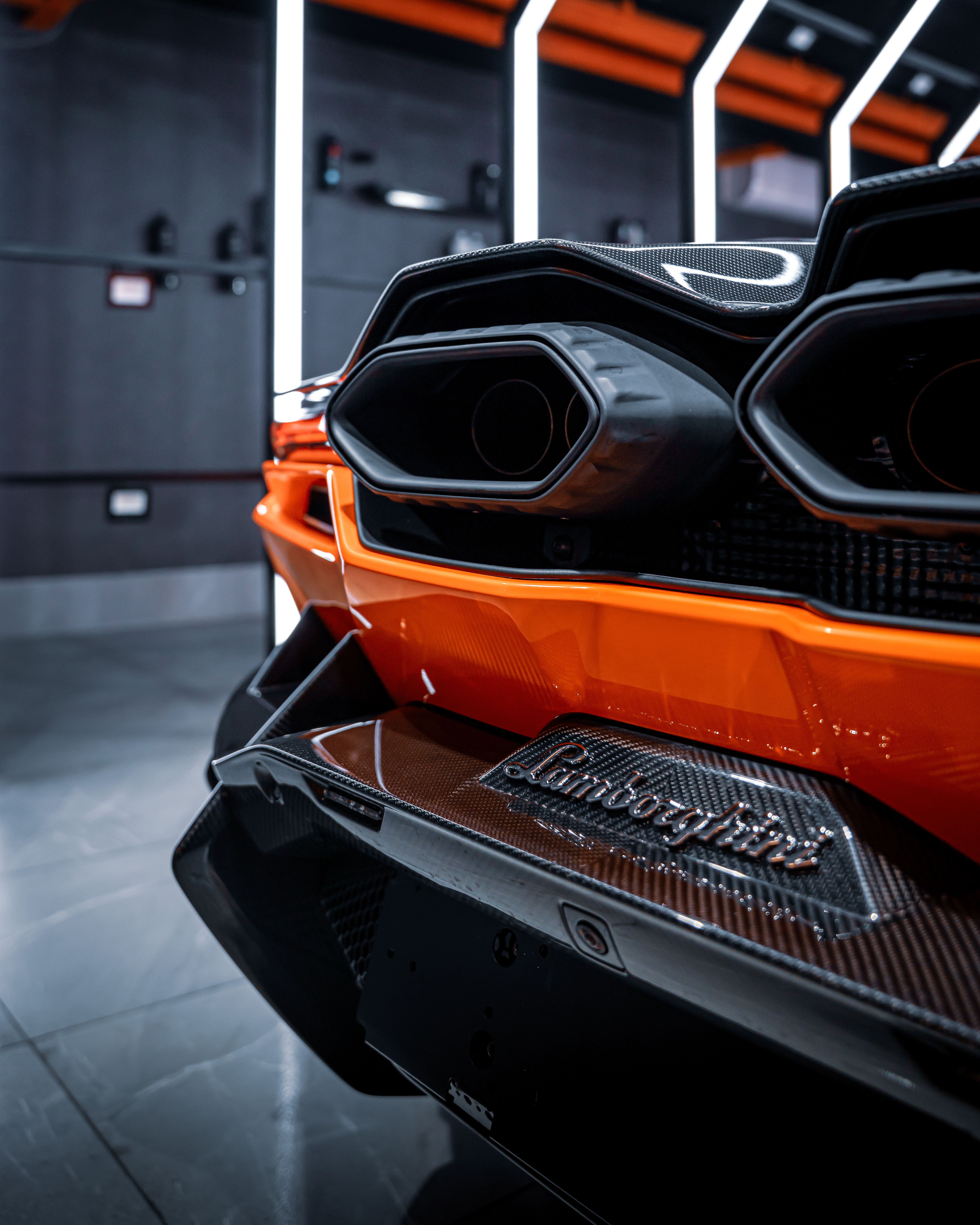 Close-up of Orange Lamborghini Exhaust in Showroom · Free Stock Photo