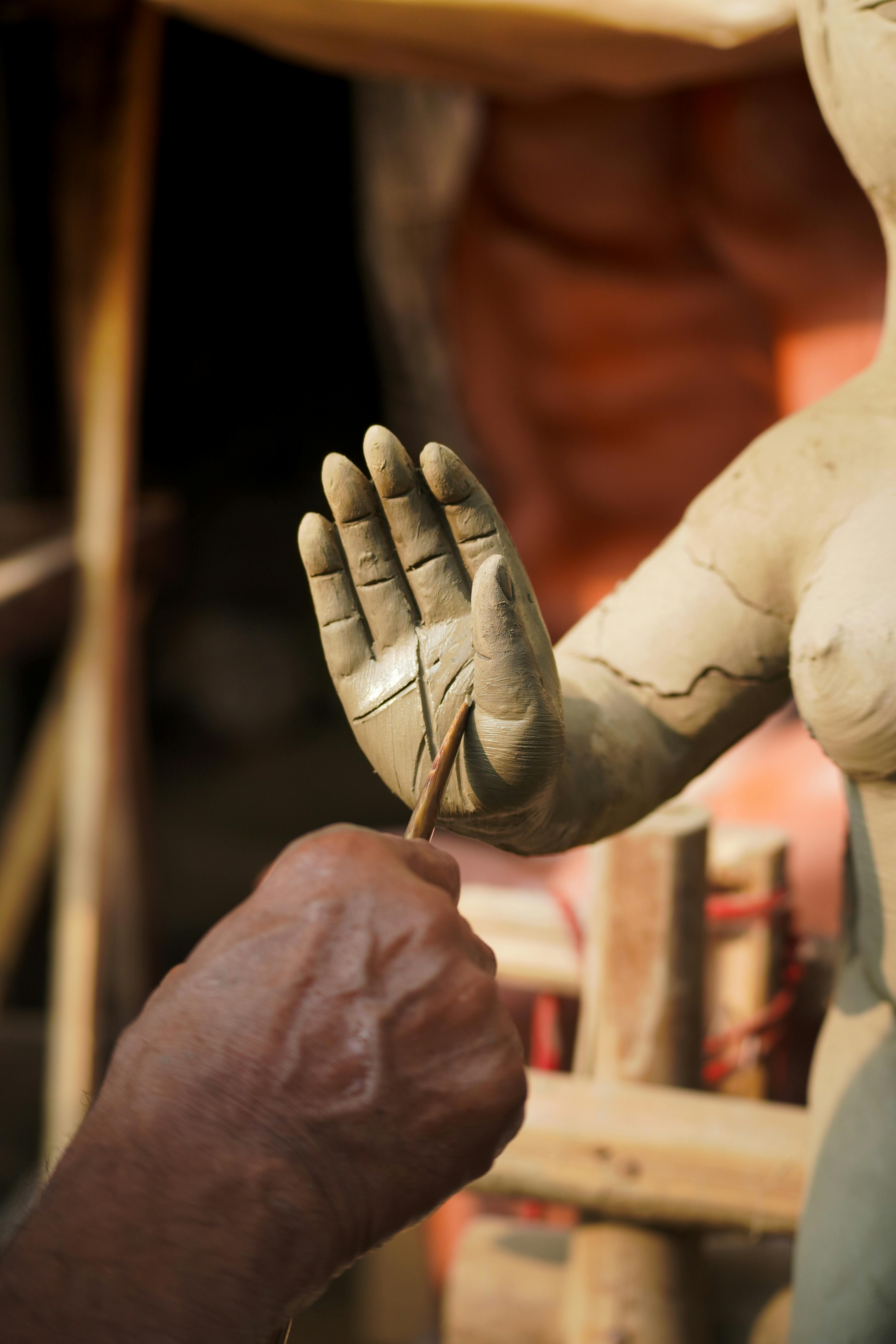 Hands Crafting a Clay Statue in Artisan Workshop · Free Stock Photo