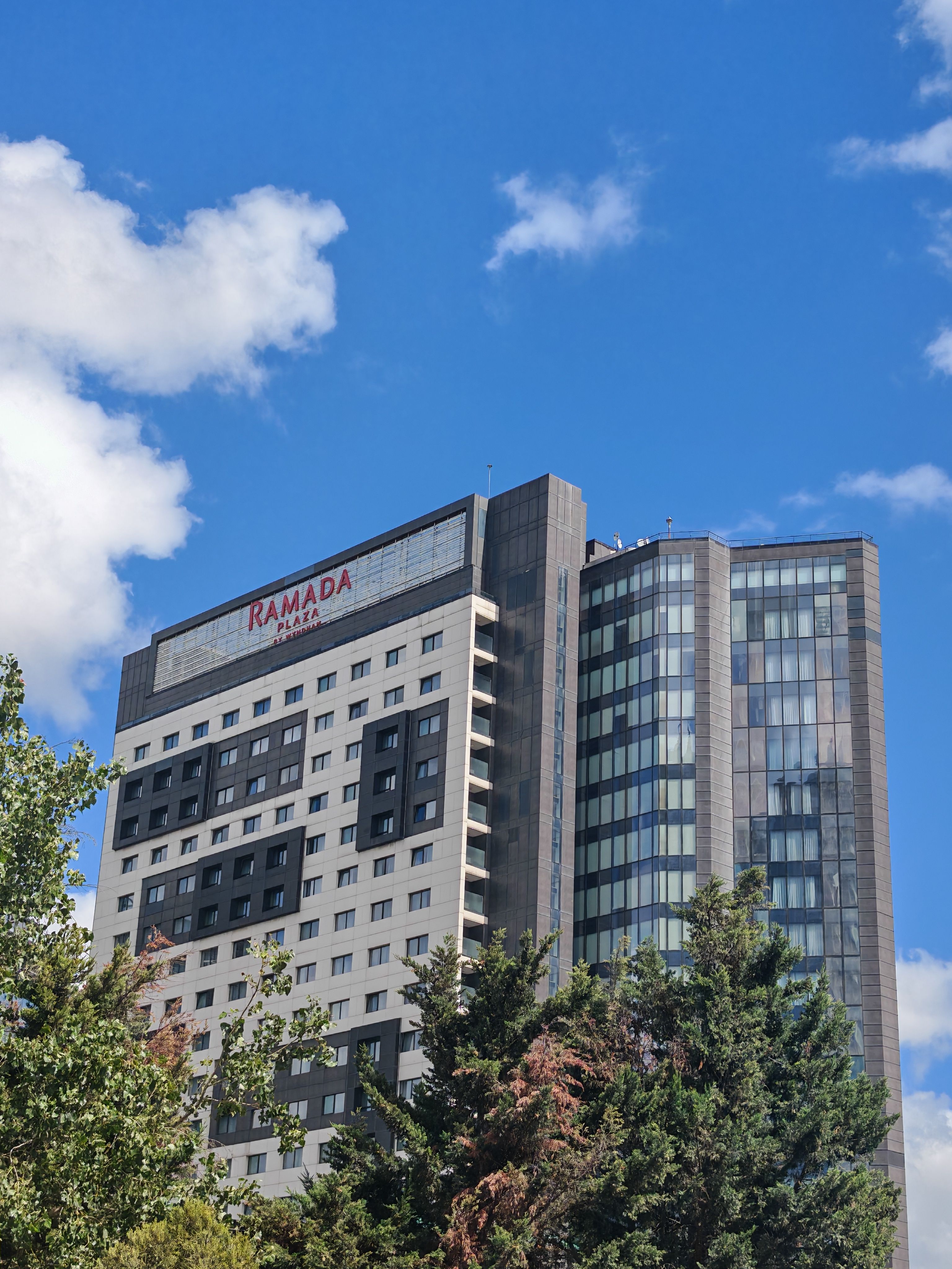 Ramada Hotel Against Clear Blue Sky · Free Stock Photo