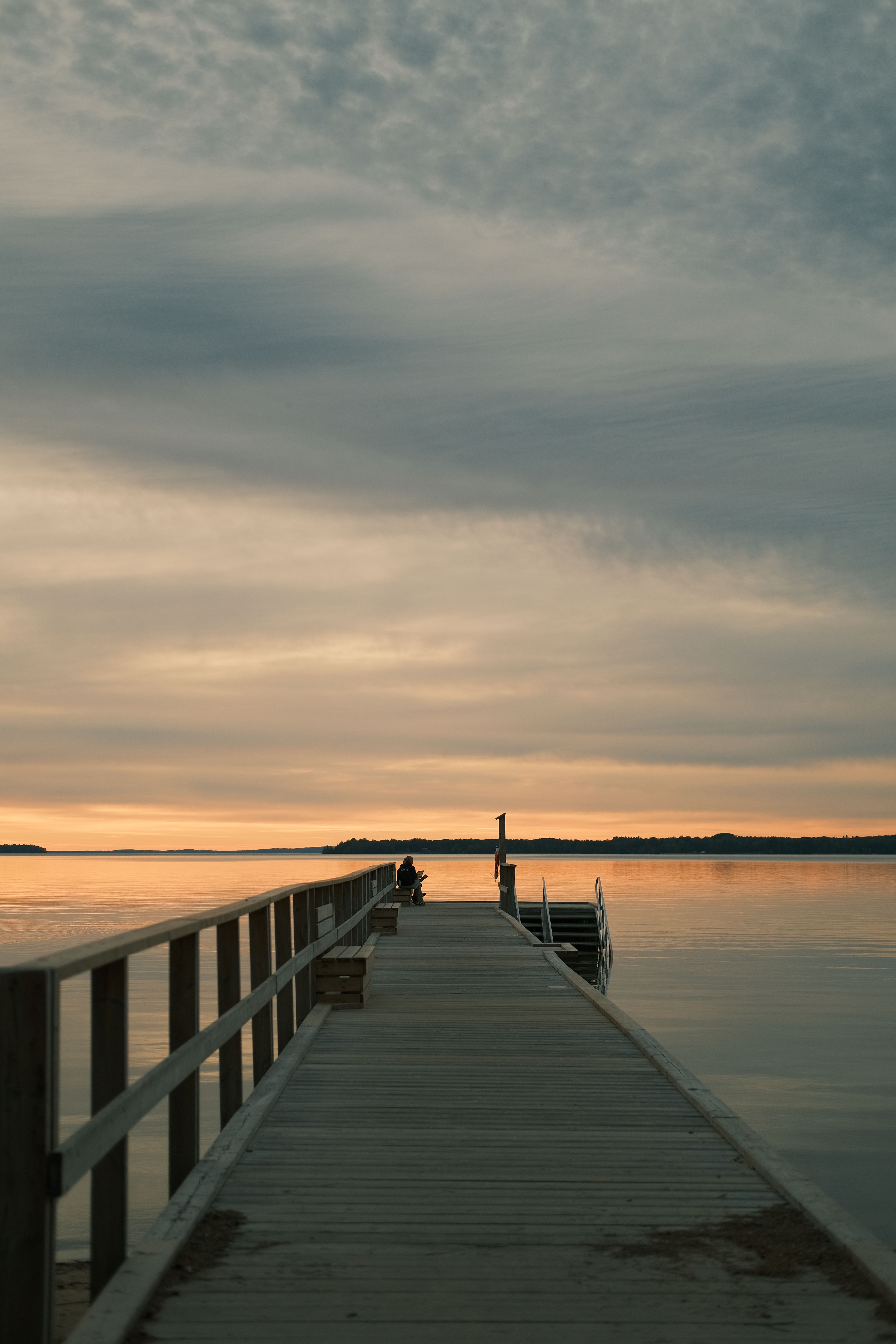 Peaceful Lakeside Dock at Sunrise with Calm Water · Free Stock Photo