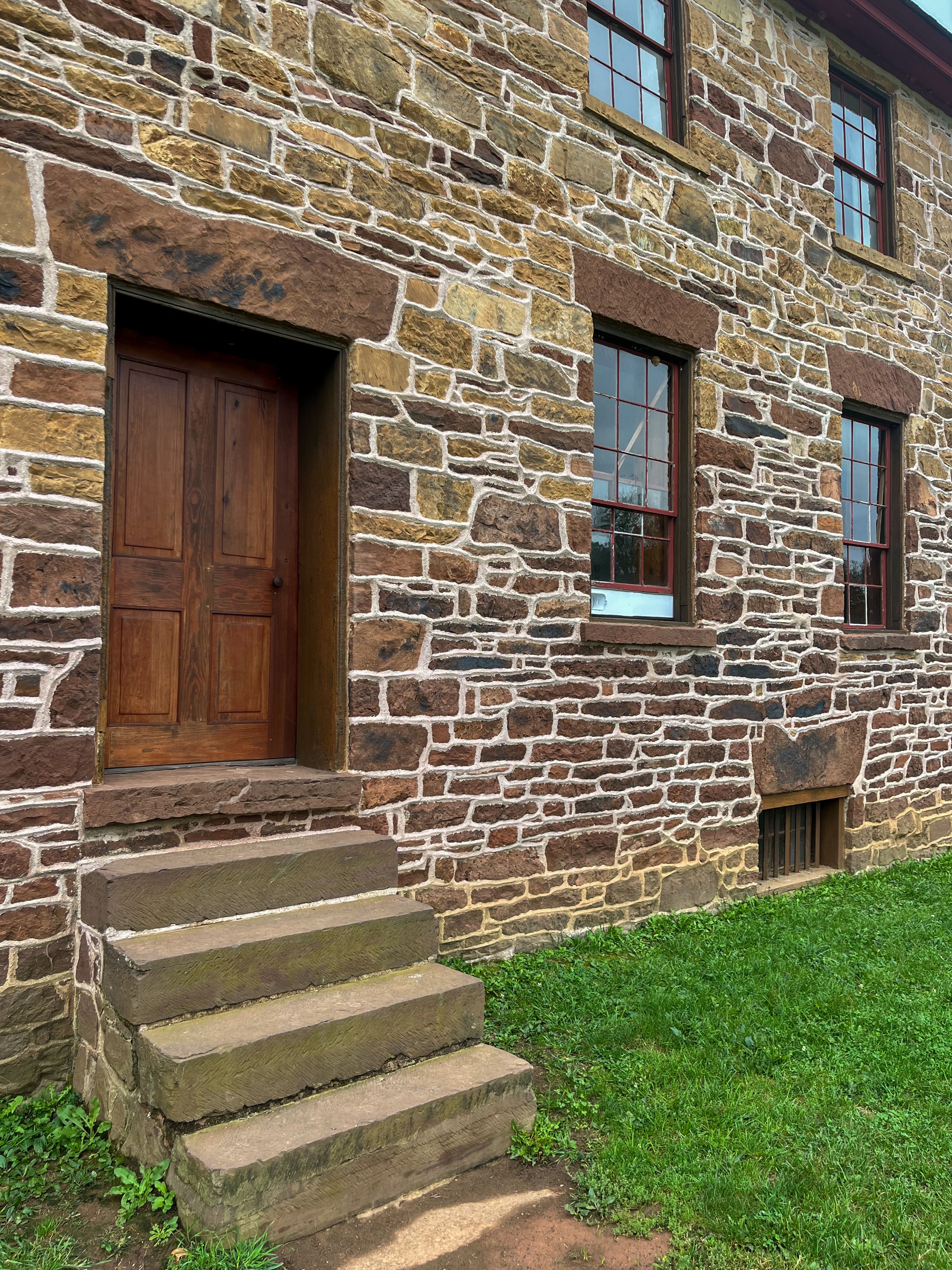 Historic Stone Building Exterior with Green Lawn · Free Stock Photo