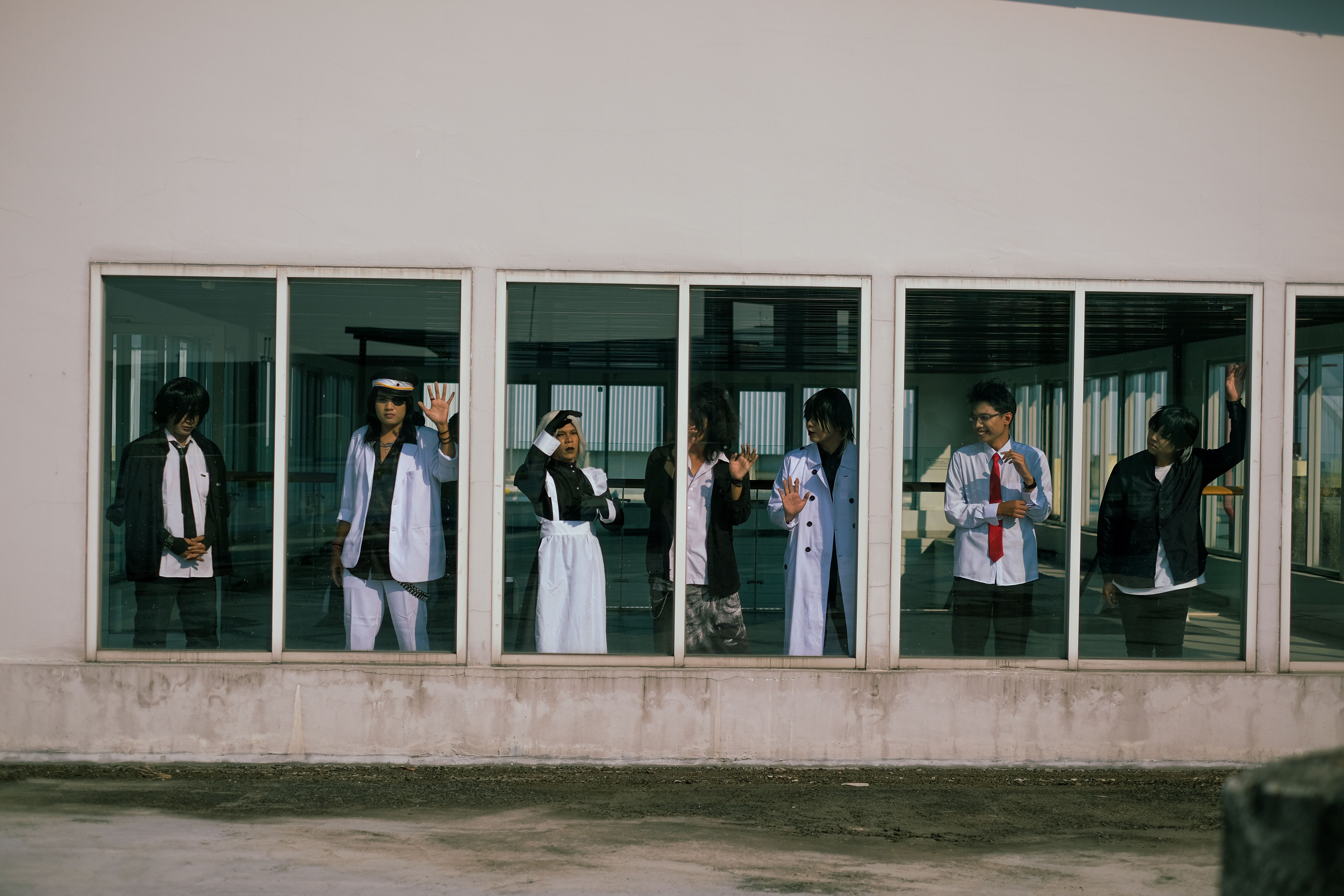 Window View of People in Varied Outfits · Free Stock Photo