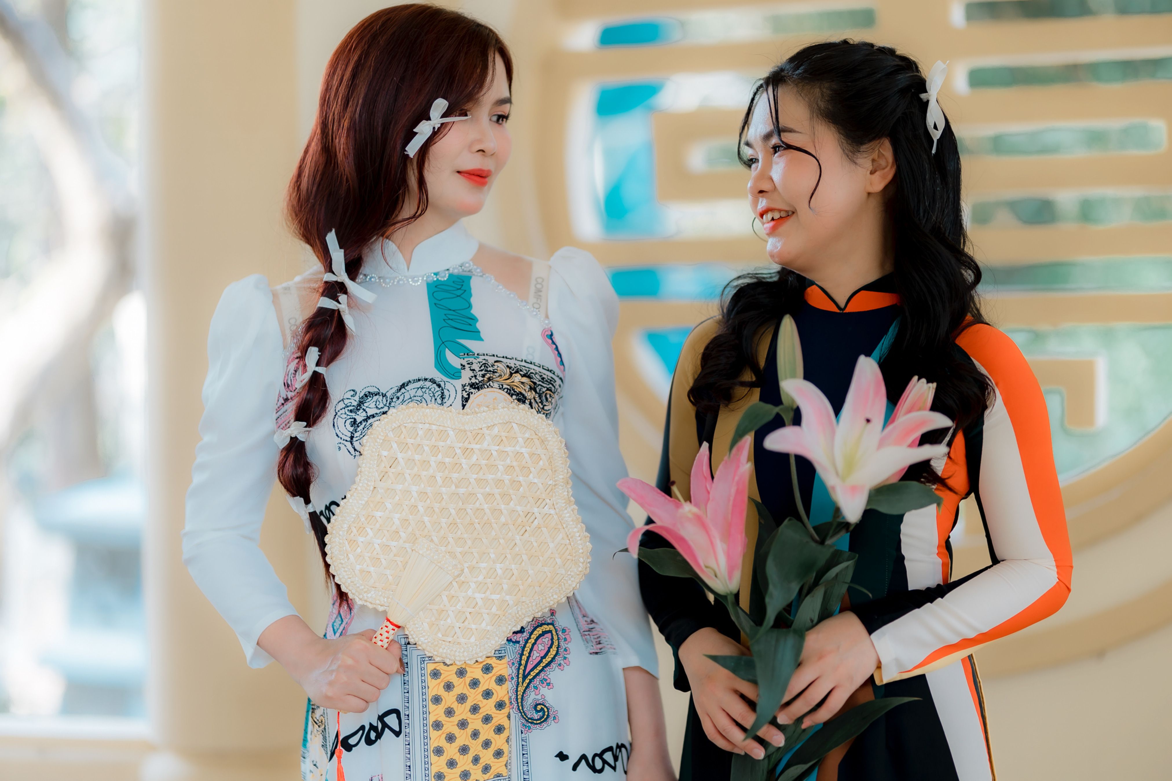 Two Women in Colorful Dresses Smiling Together · Free Stock Photo