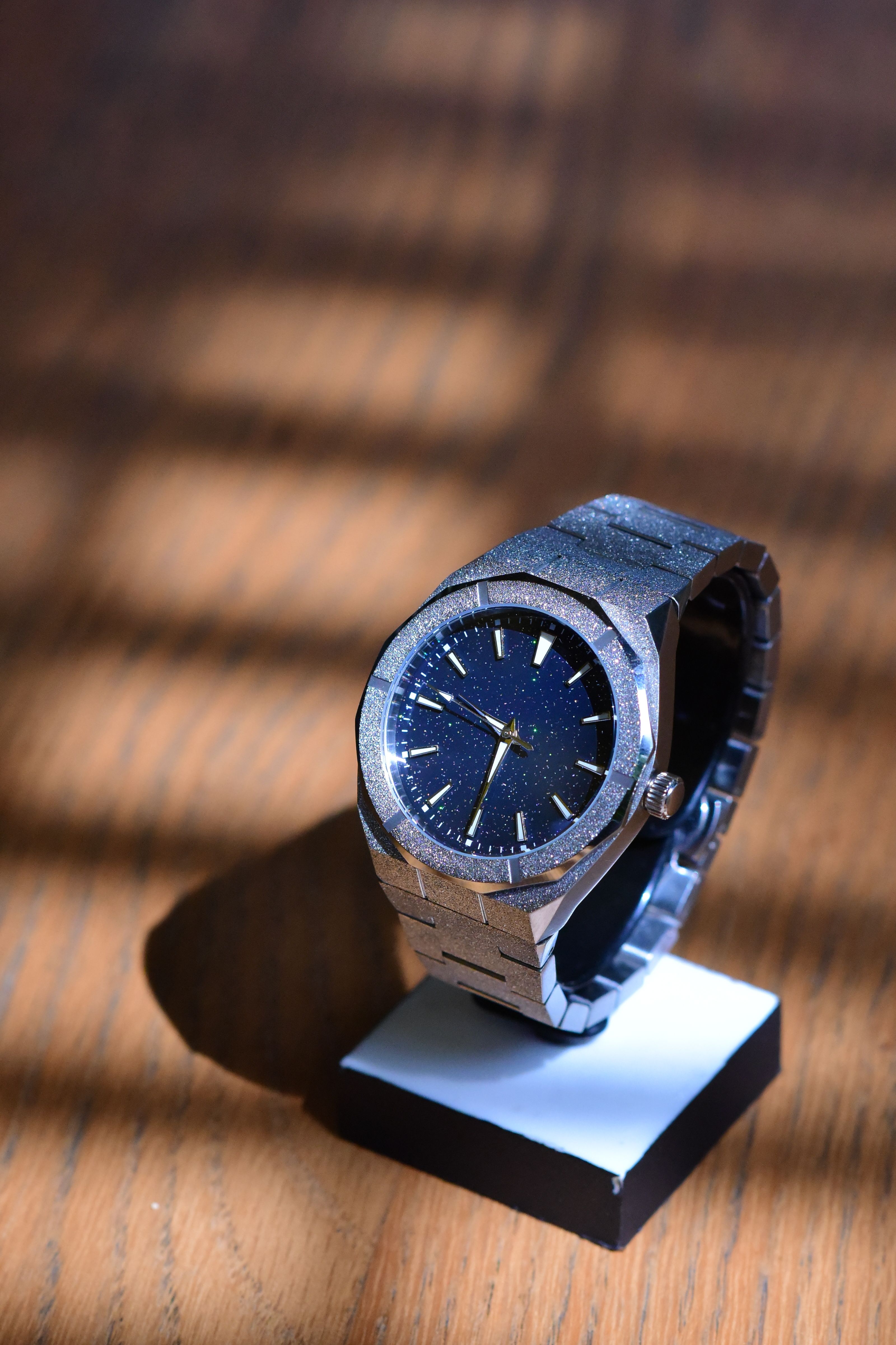 Elegant Silver Watch with Blue Dial on Display Stand · Free Stock Photo