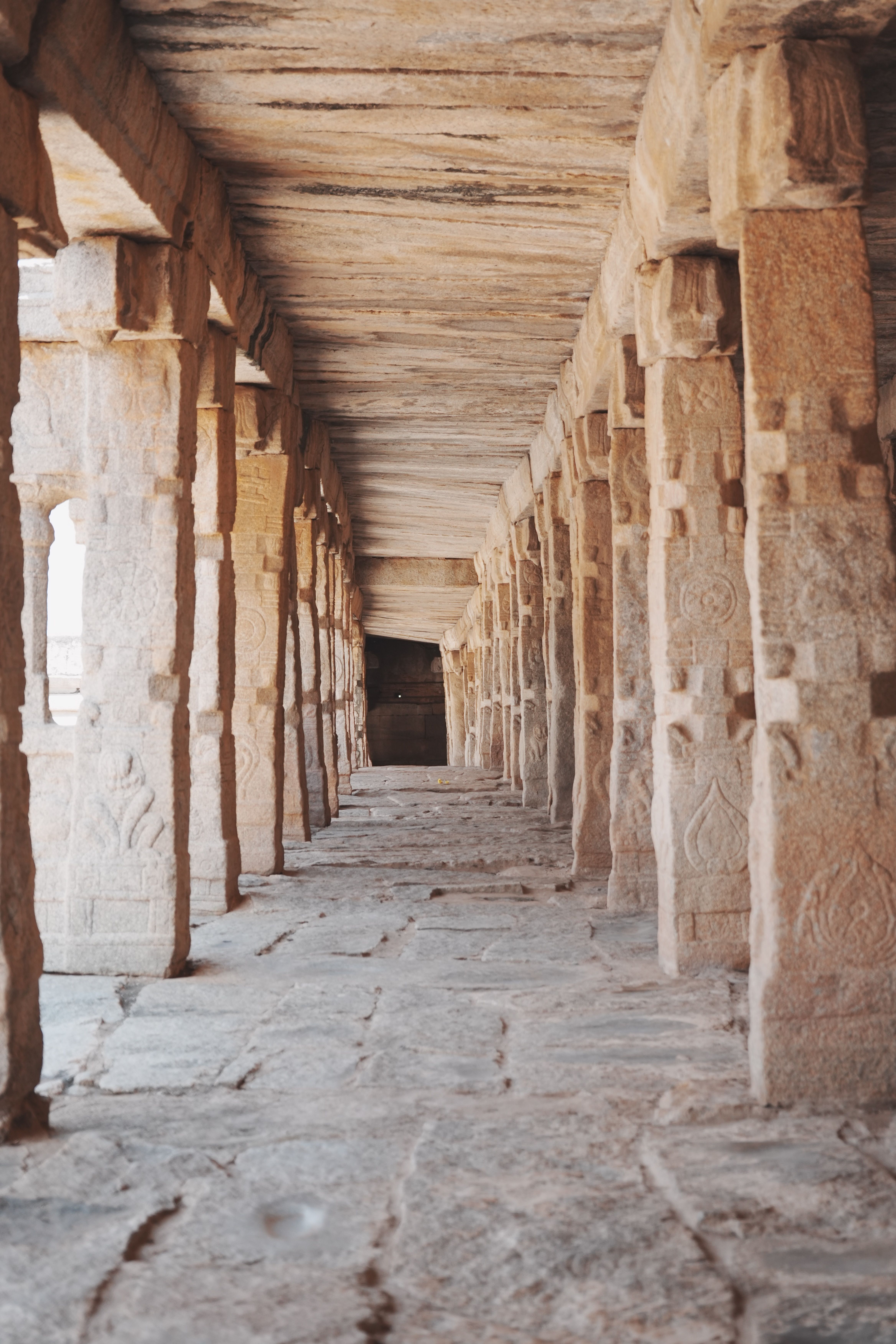 Ancient Stone Corridor with Detailed Carvings · Free Stock Photo