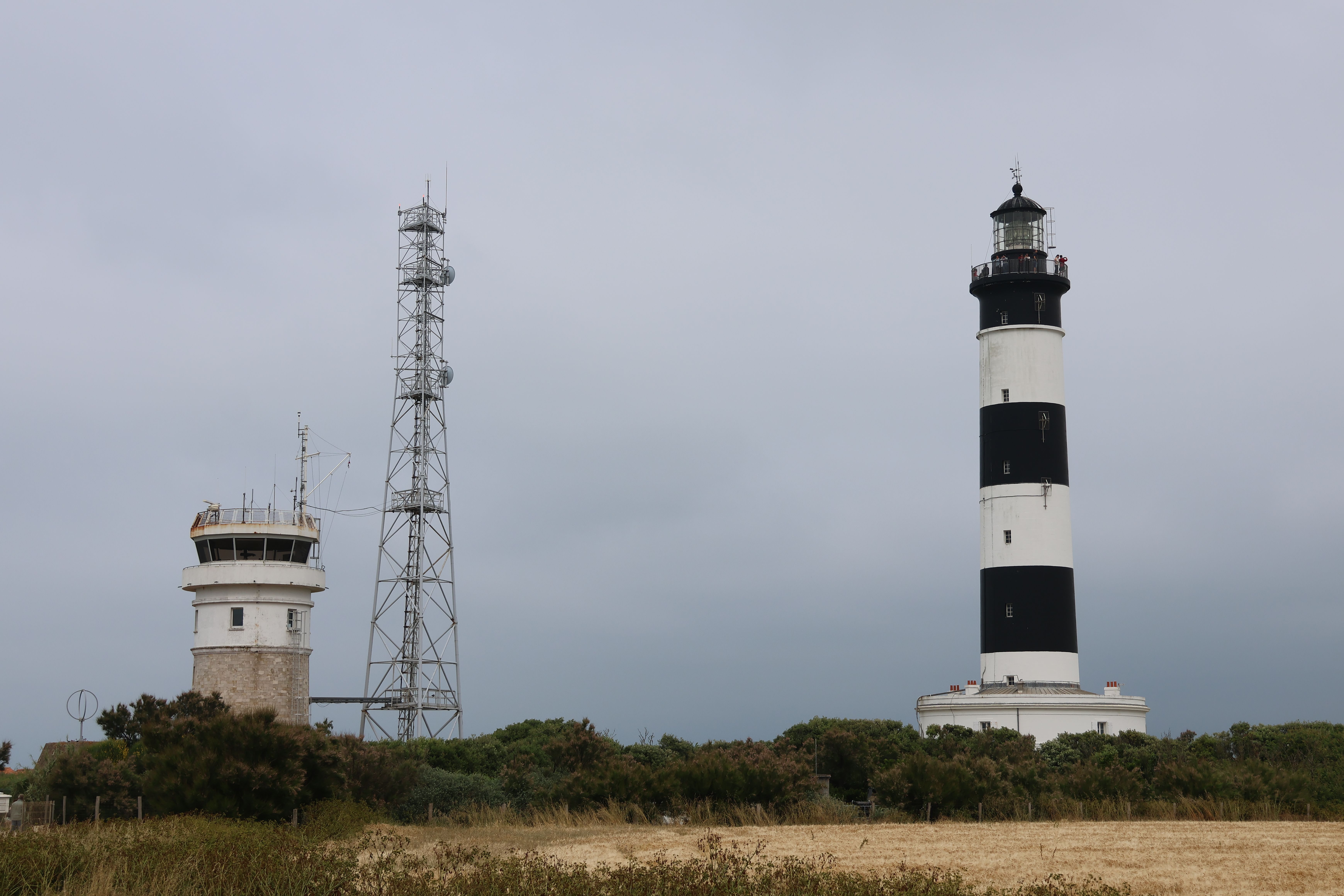 Monochrome Lighthouse Under Overcast Sky · Free Stock Photo