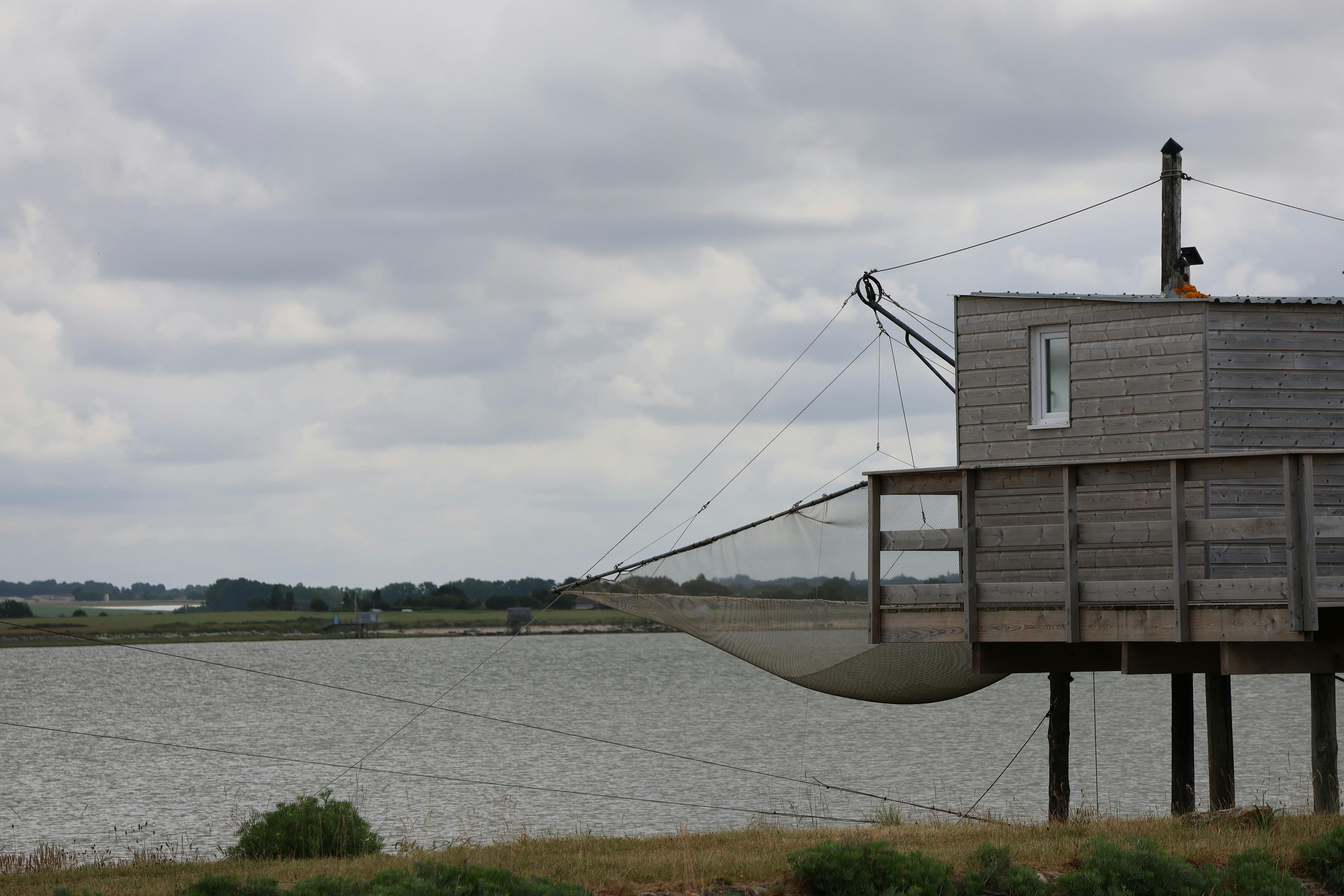 Wooden Fishing Hut Overlooking Serene Lake · Free Stock Photo