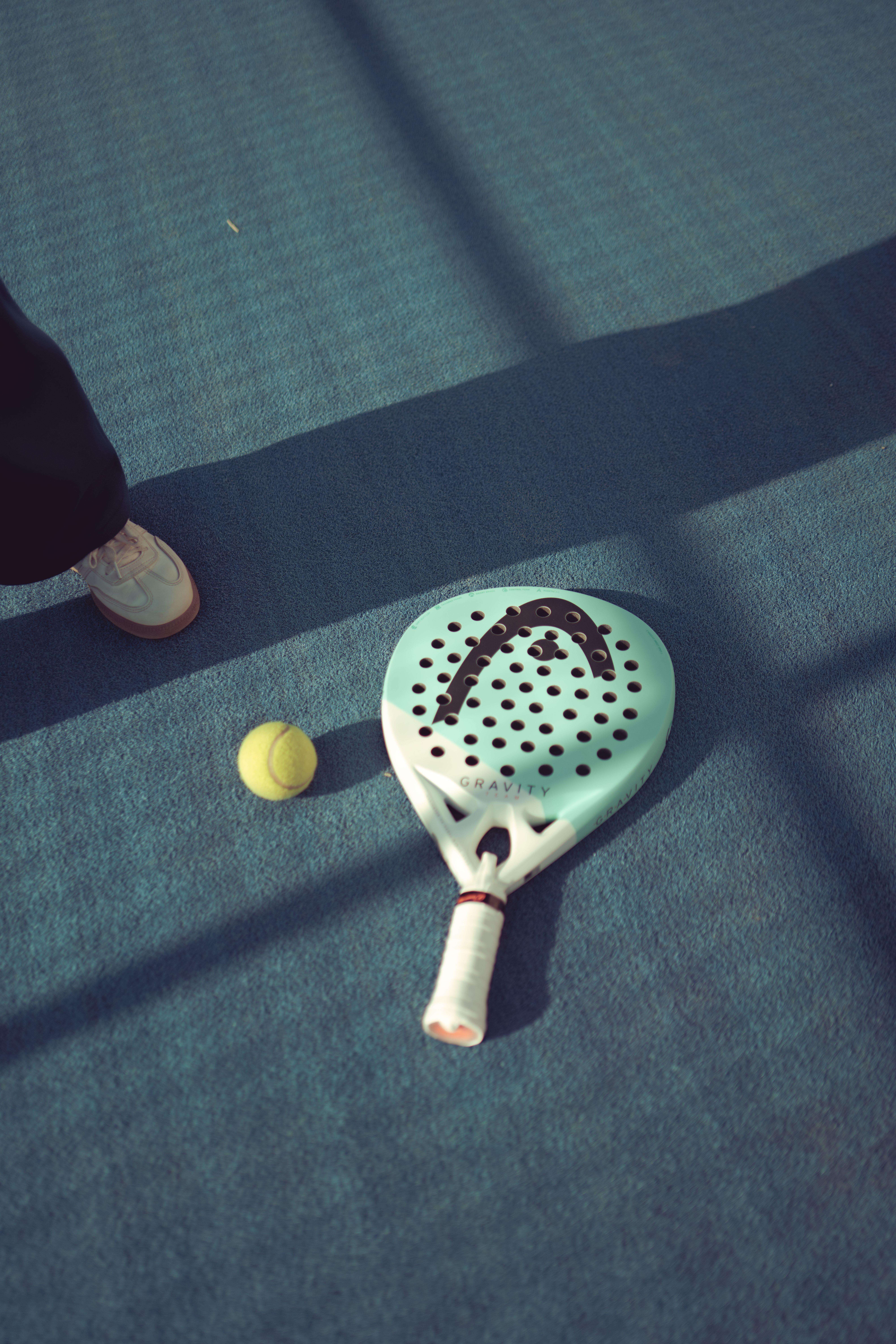 Padel Racket and Ball on Blue Court · Free Stock Photo
