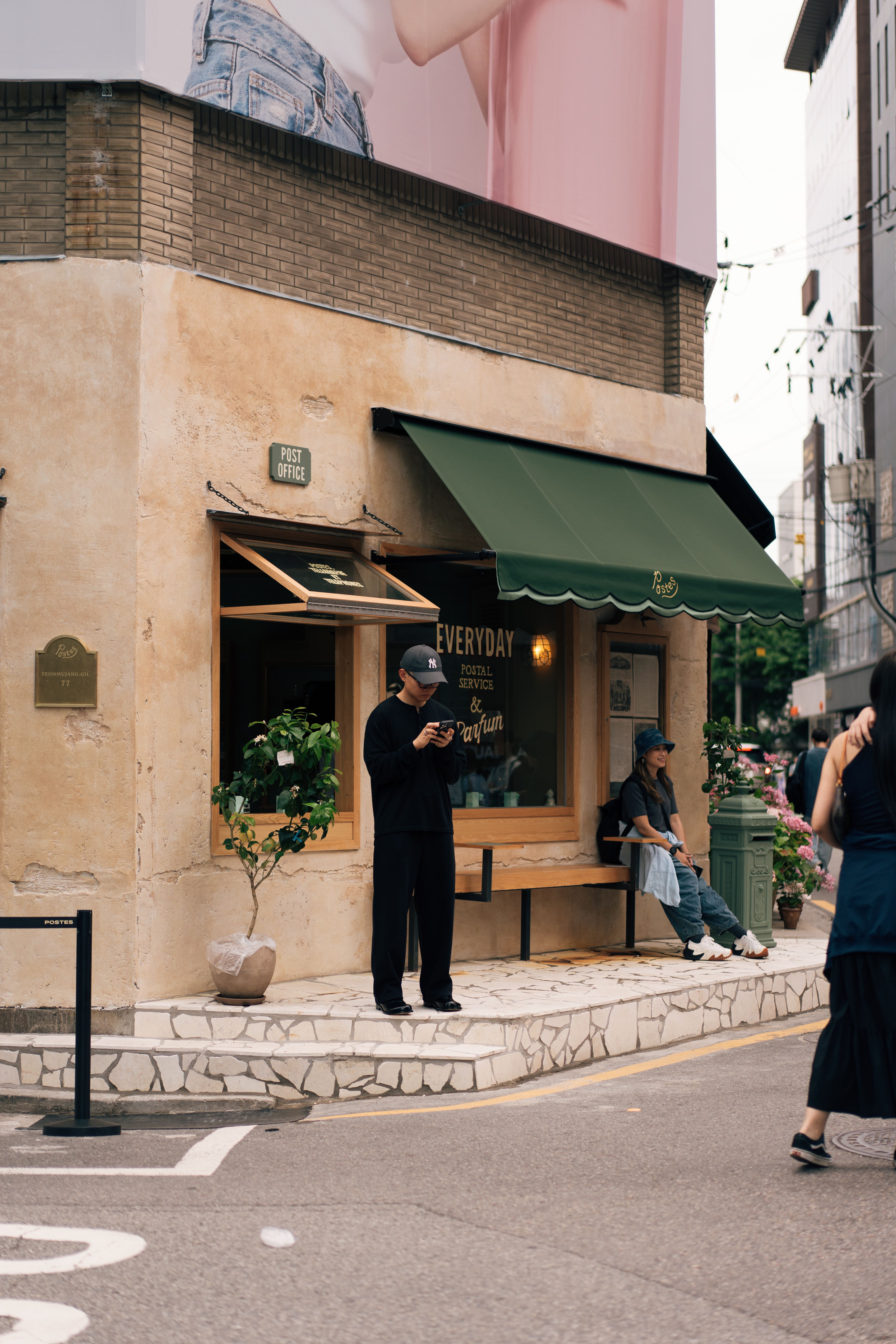 Urban Street Scene with People at a Cafe Corner · Free Stock Photo