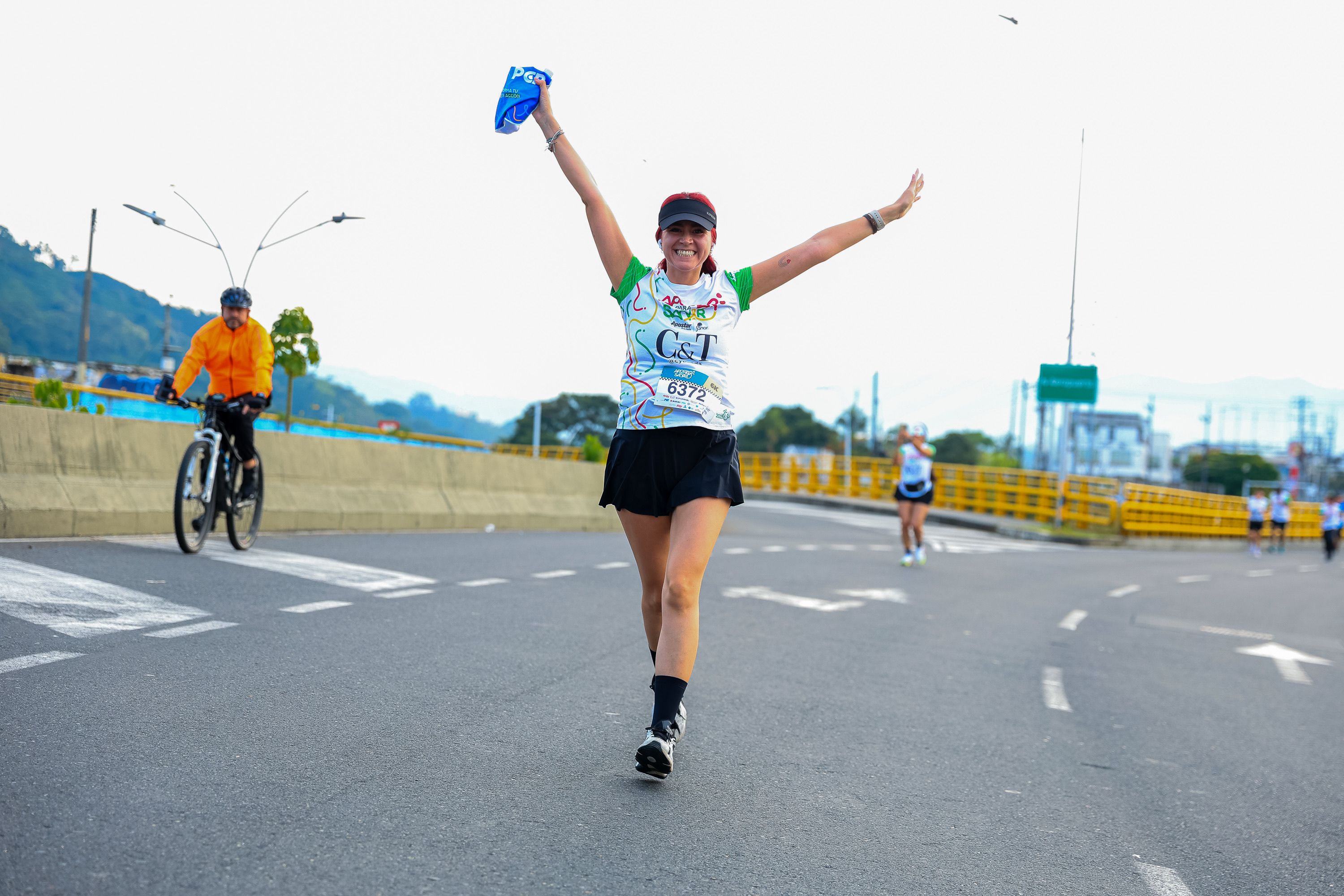 Joyful Marathon Runner Celebrating on Road · Free Stock Photo