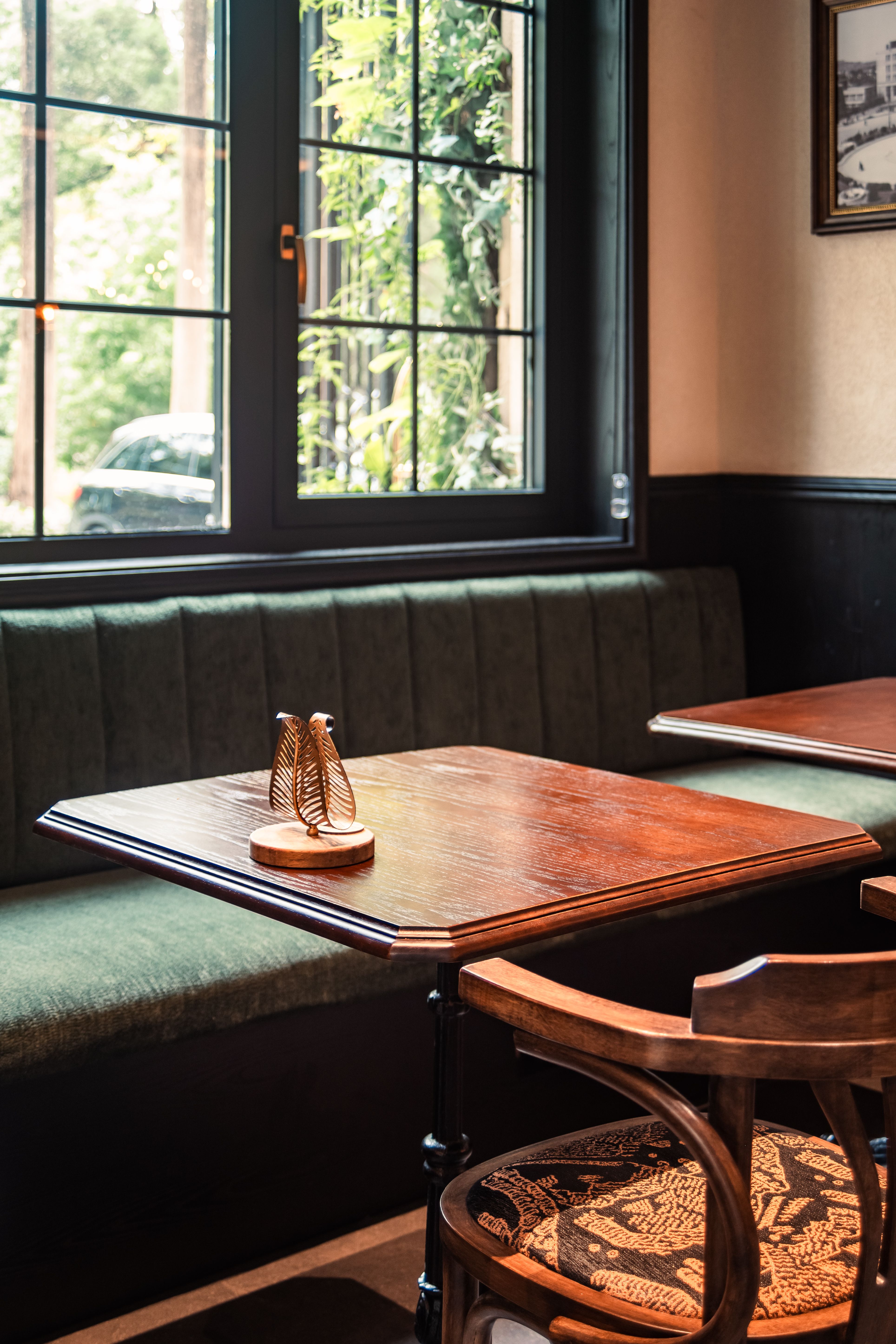 Cozy Coffee Shop Corner with Wooden Table · Free Stock Photo