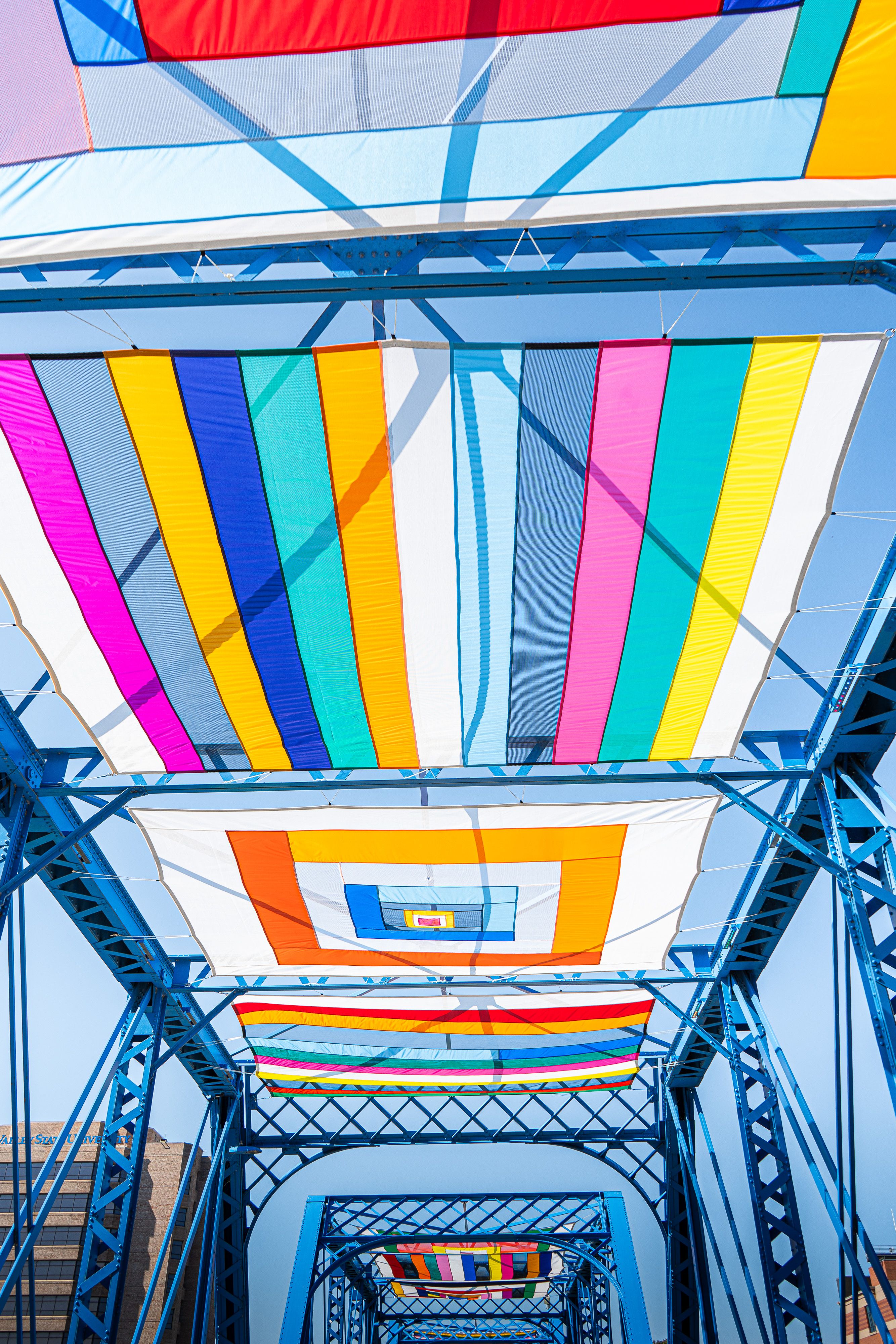 Vibrant Colorful Canopy Installation on Blue Bridge · Free Stock Photo