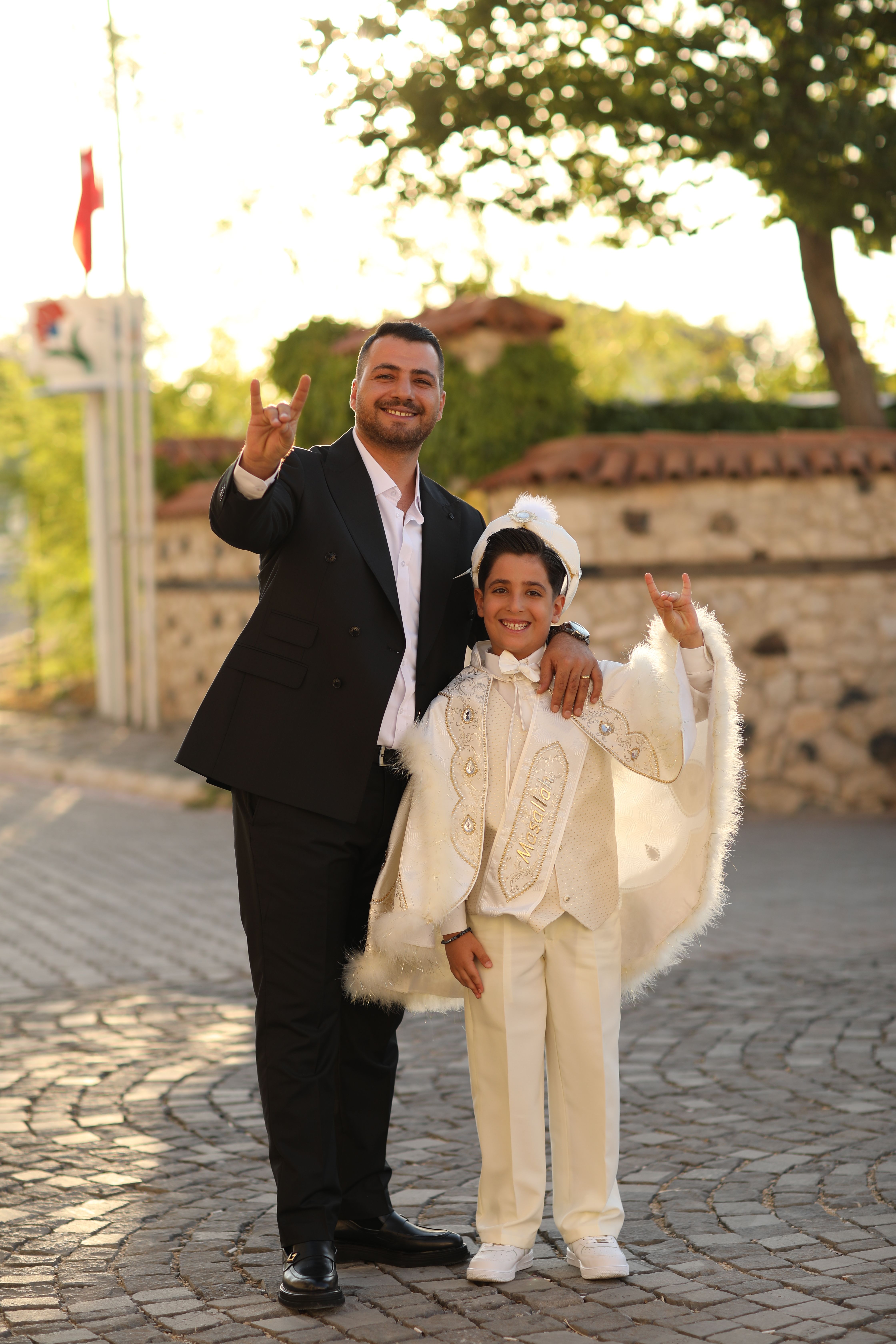Father and Son Celebrating in Traditional Attire · Free Stock Photo