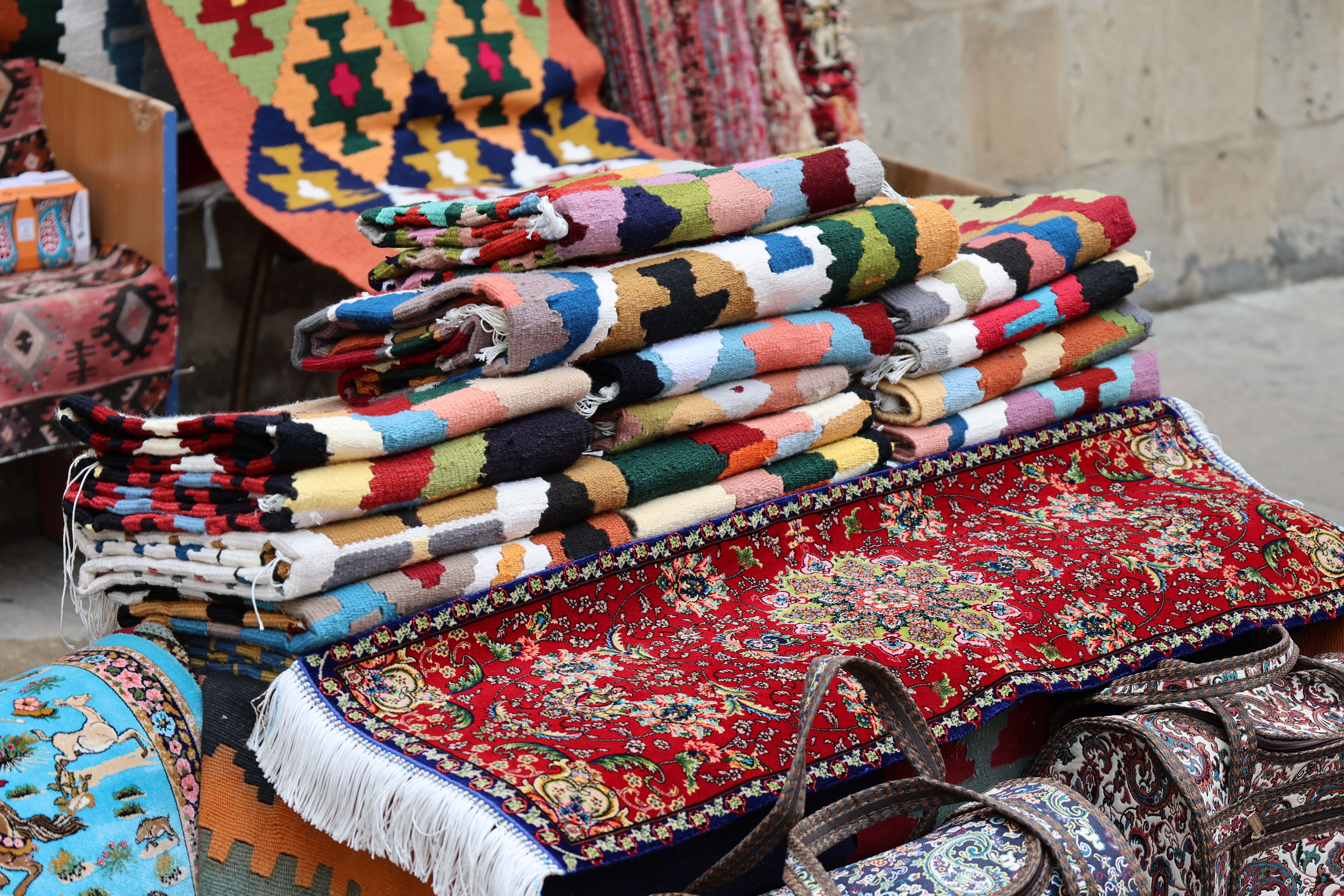 Colorful Display of Traditional Woven Rugs · Free Stock Photo