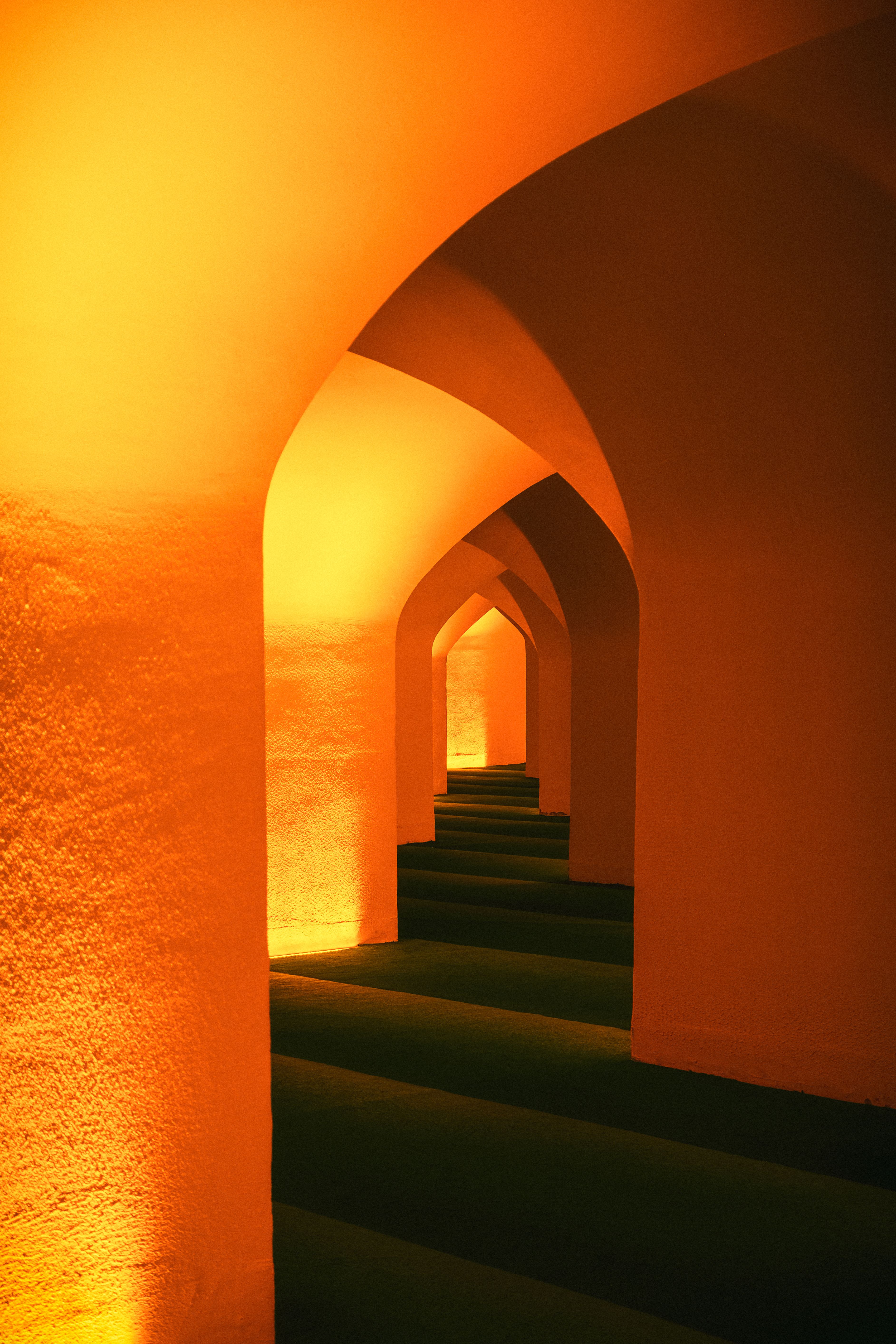Atmospheric Arched Corridor in Warm Lighting · Free Stock Photo