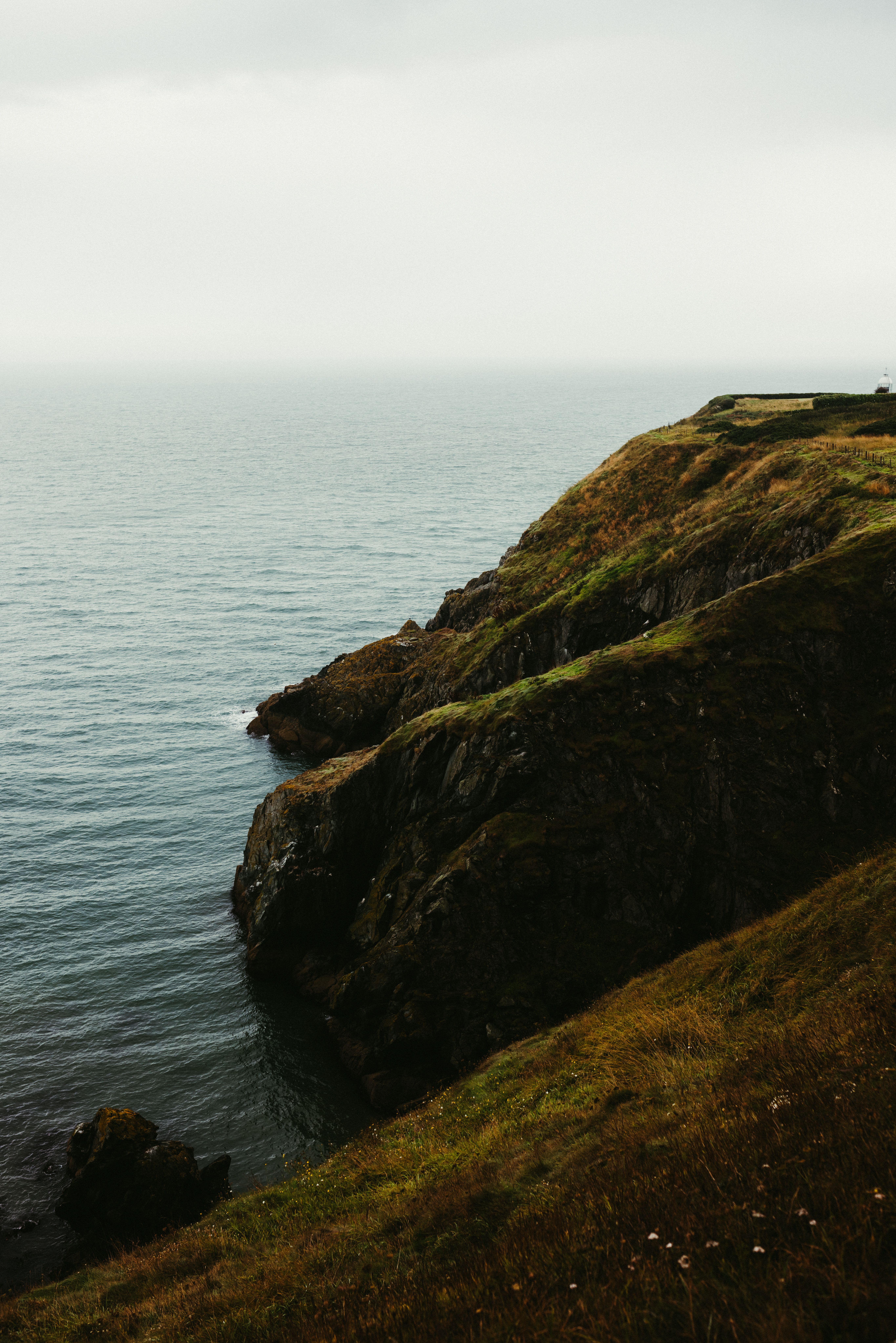 Rocky slope on coast of bay · Free Stock Photo