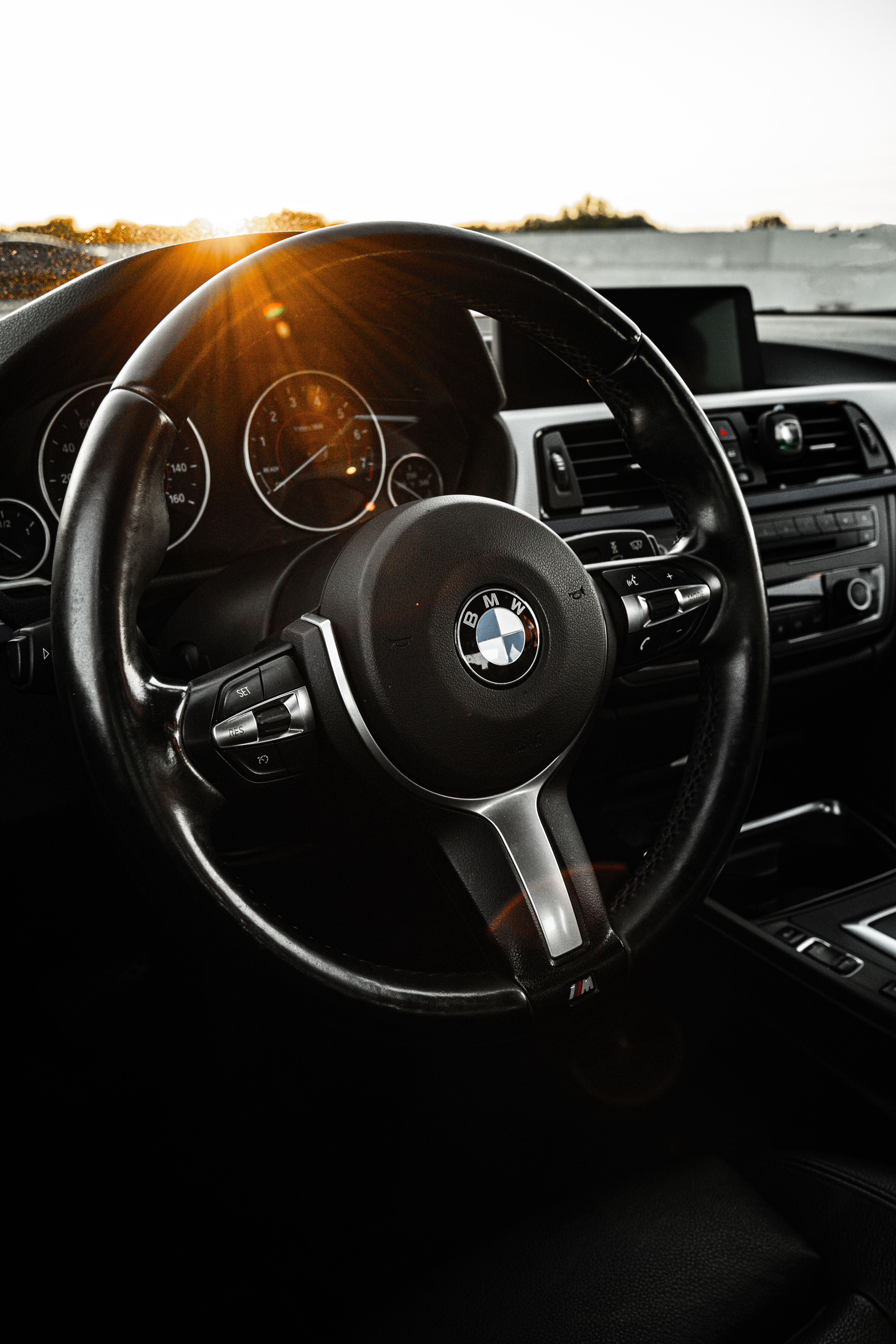 Luxury Car Steering Wheel with Sunlight Flare · Free Stock Photo