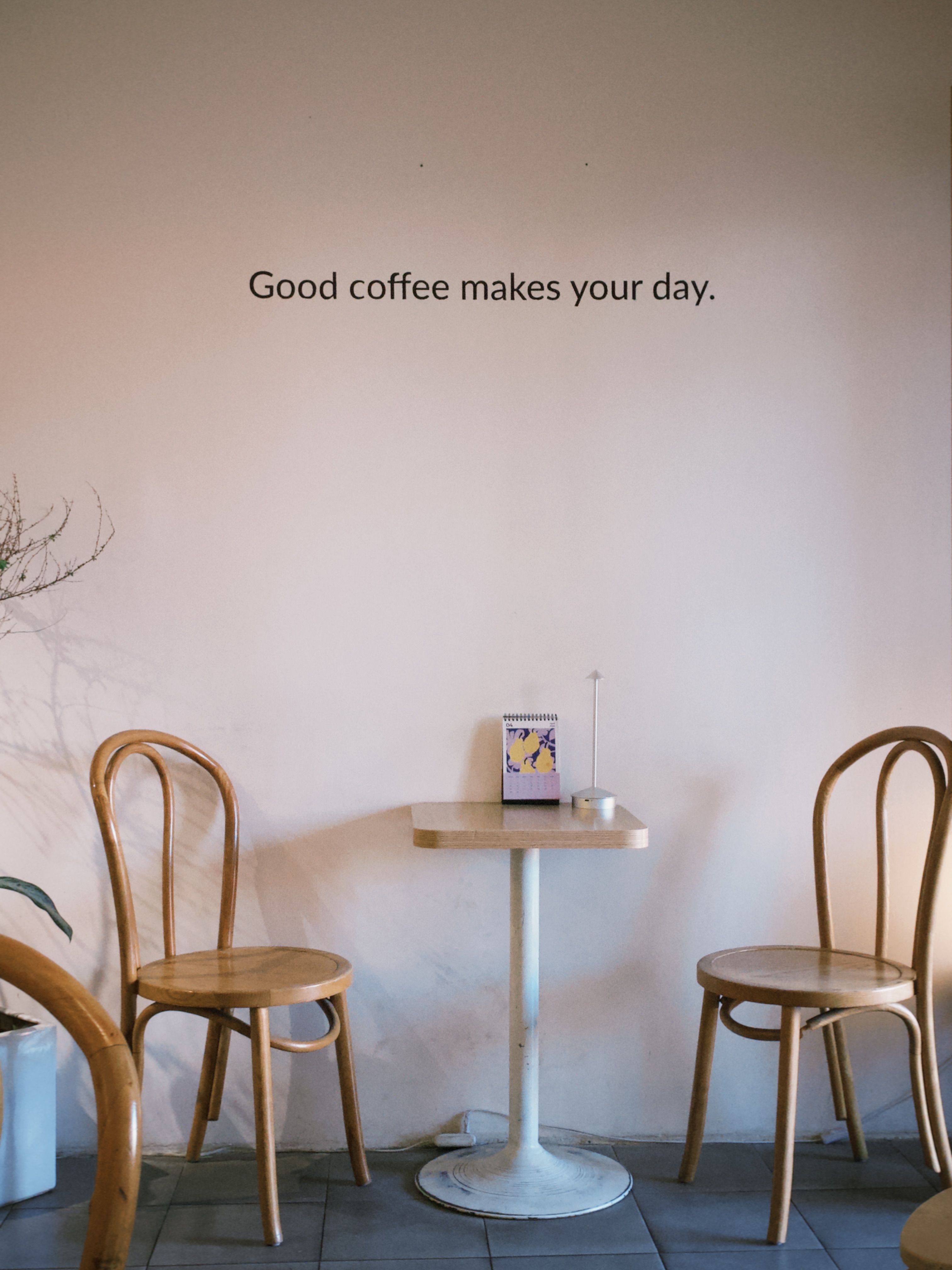 Minimalist Cafe Interior with Coffee Quote · Free Stock Photo