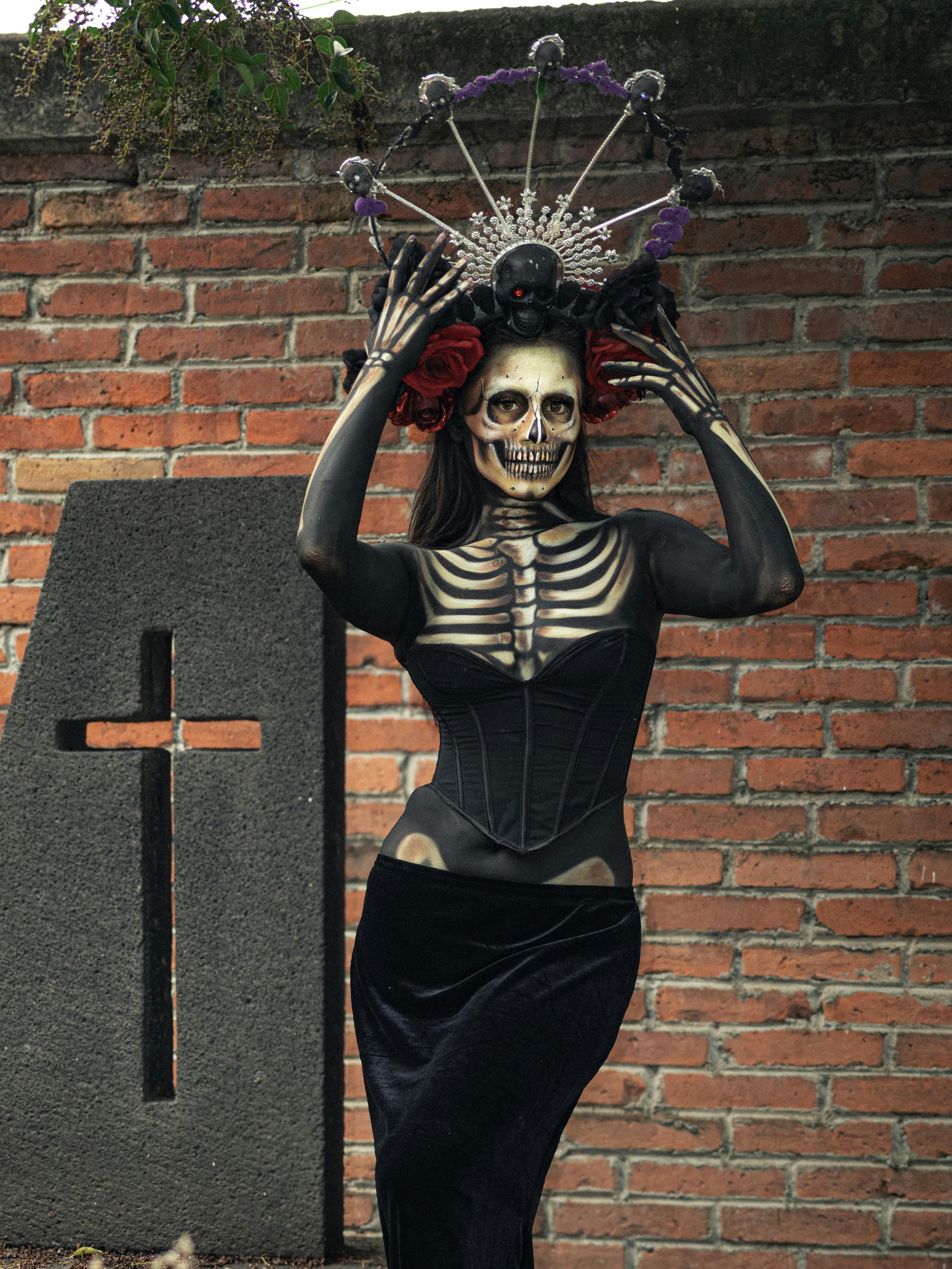 Skeleton Costume with Intricate Headpiece in Cemetery · Free Stock Photo