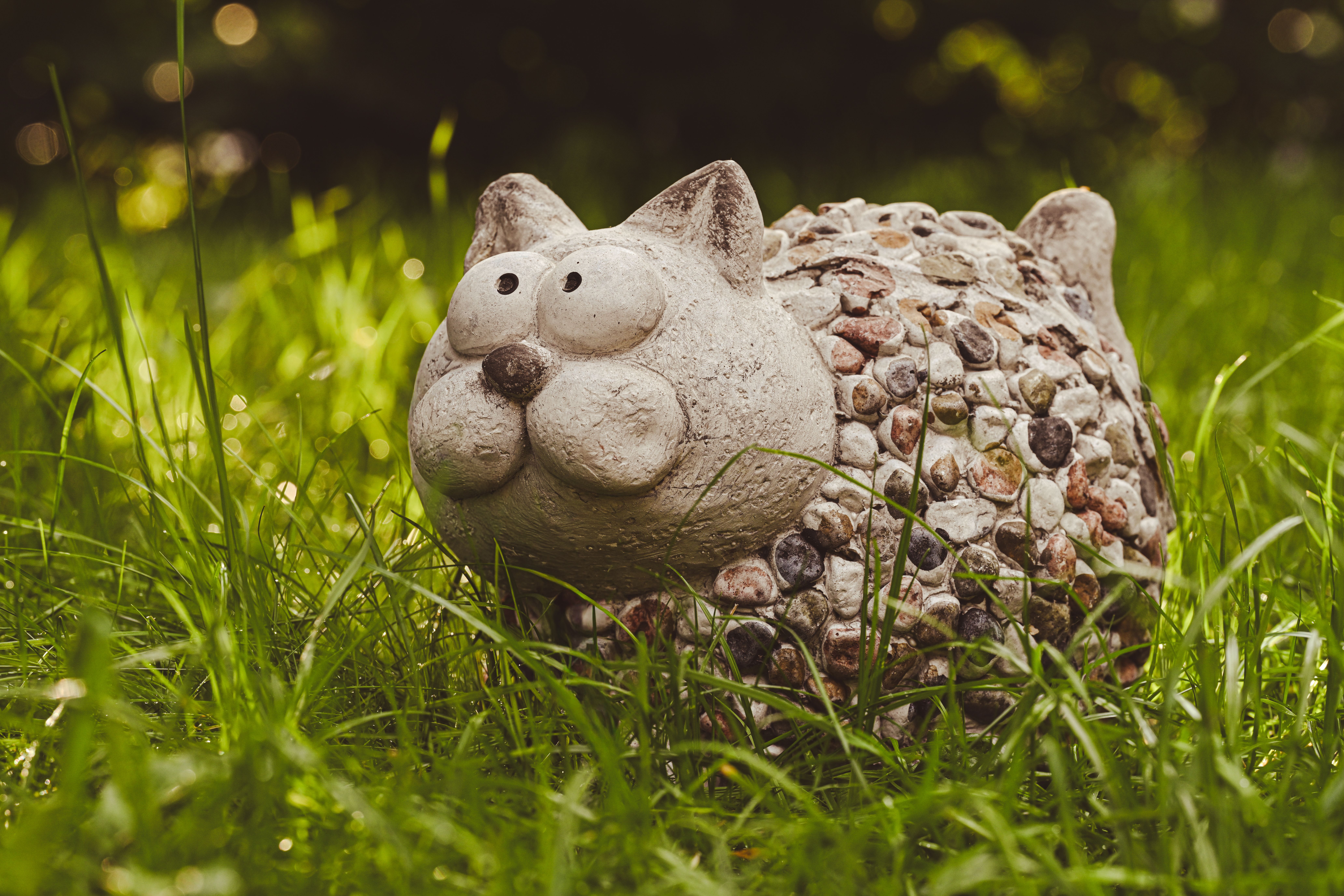 Stone Cat Figurine in Lush Green Grass · Free Stock Photo