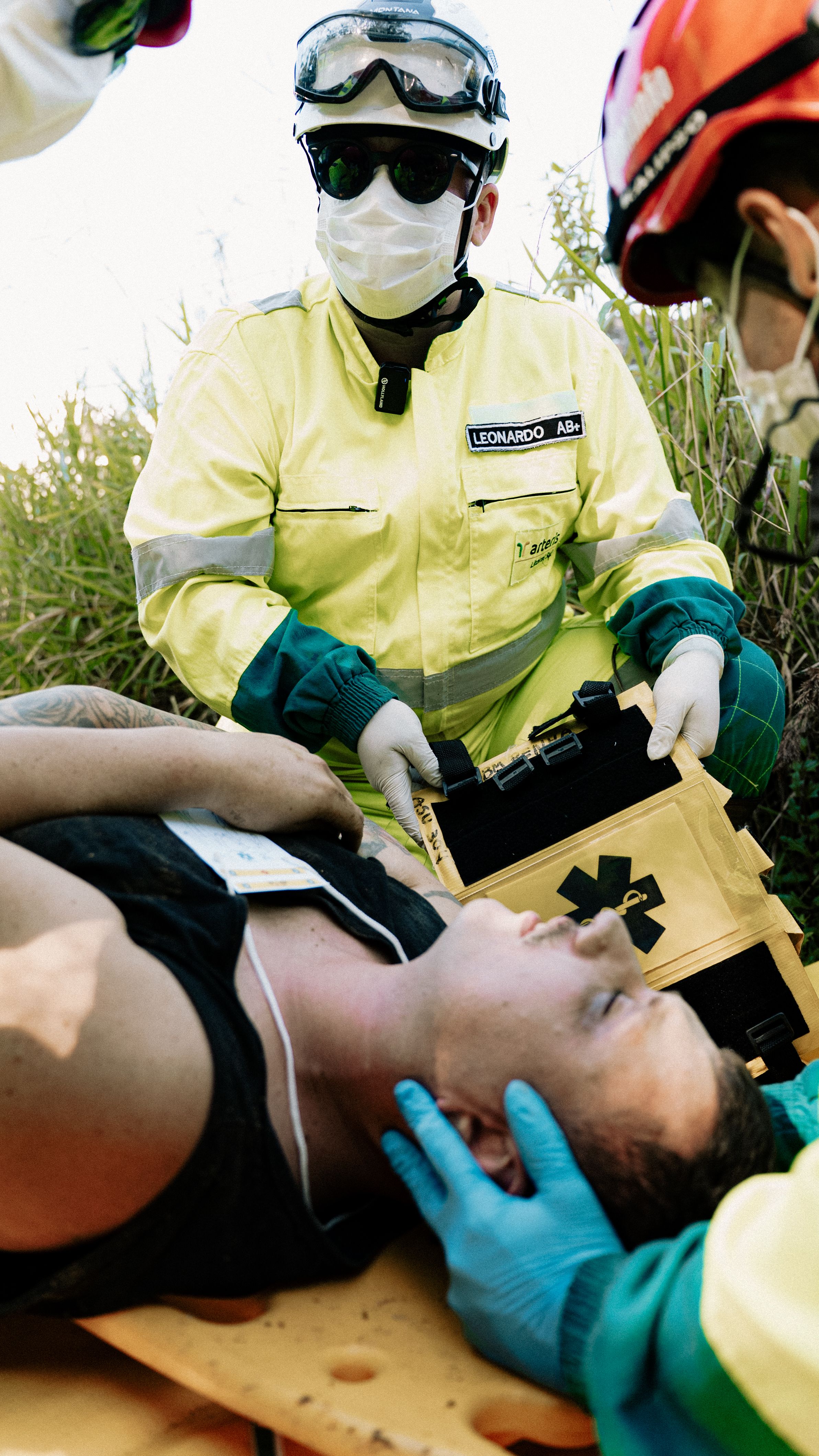 Emergency Rescue Team Assisting Injured Person Outdoors · Free Stock Photo
