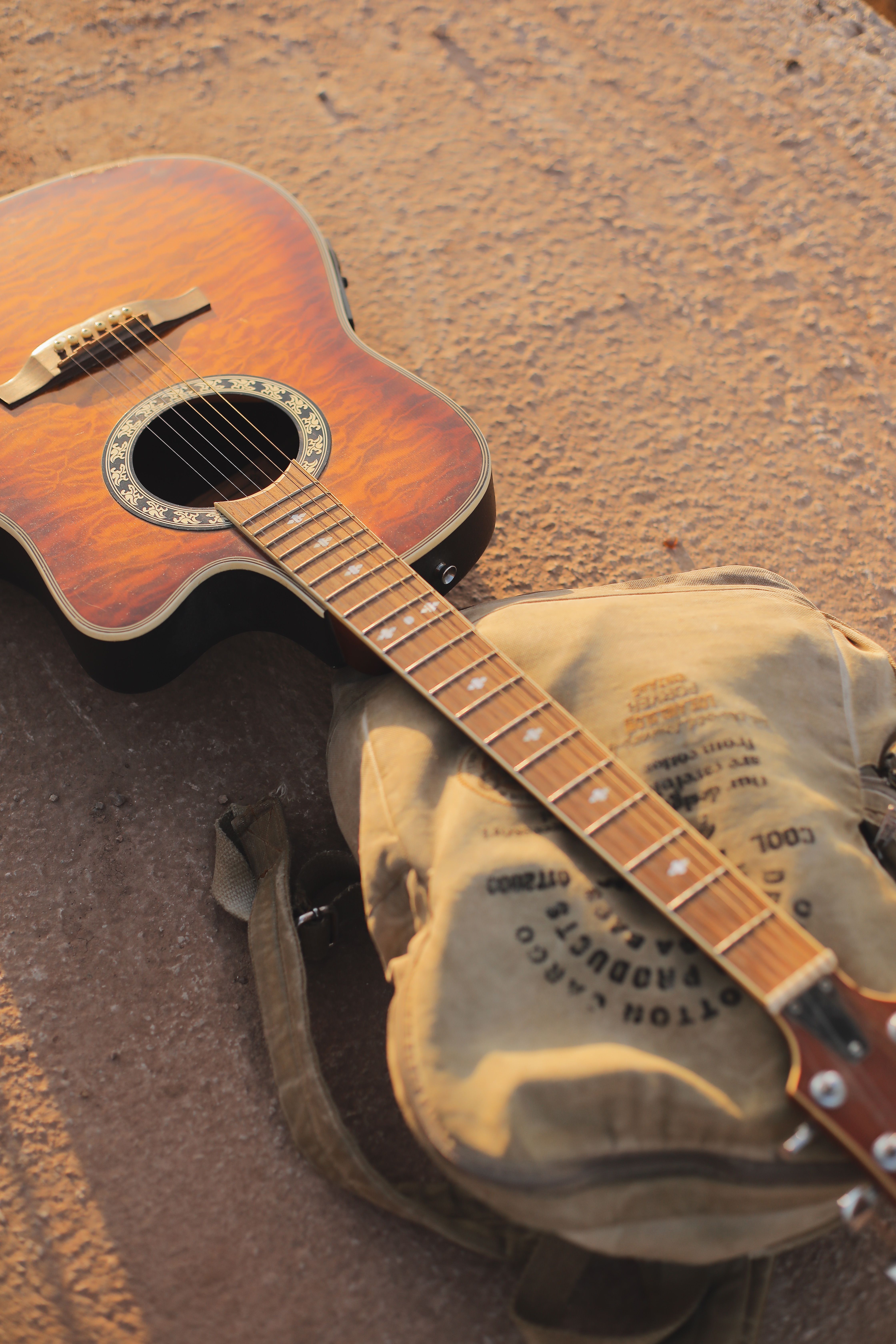 Acoustic Guitar on Sandy Ground at Sunset · Free Stock Photo