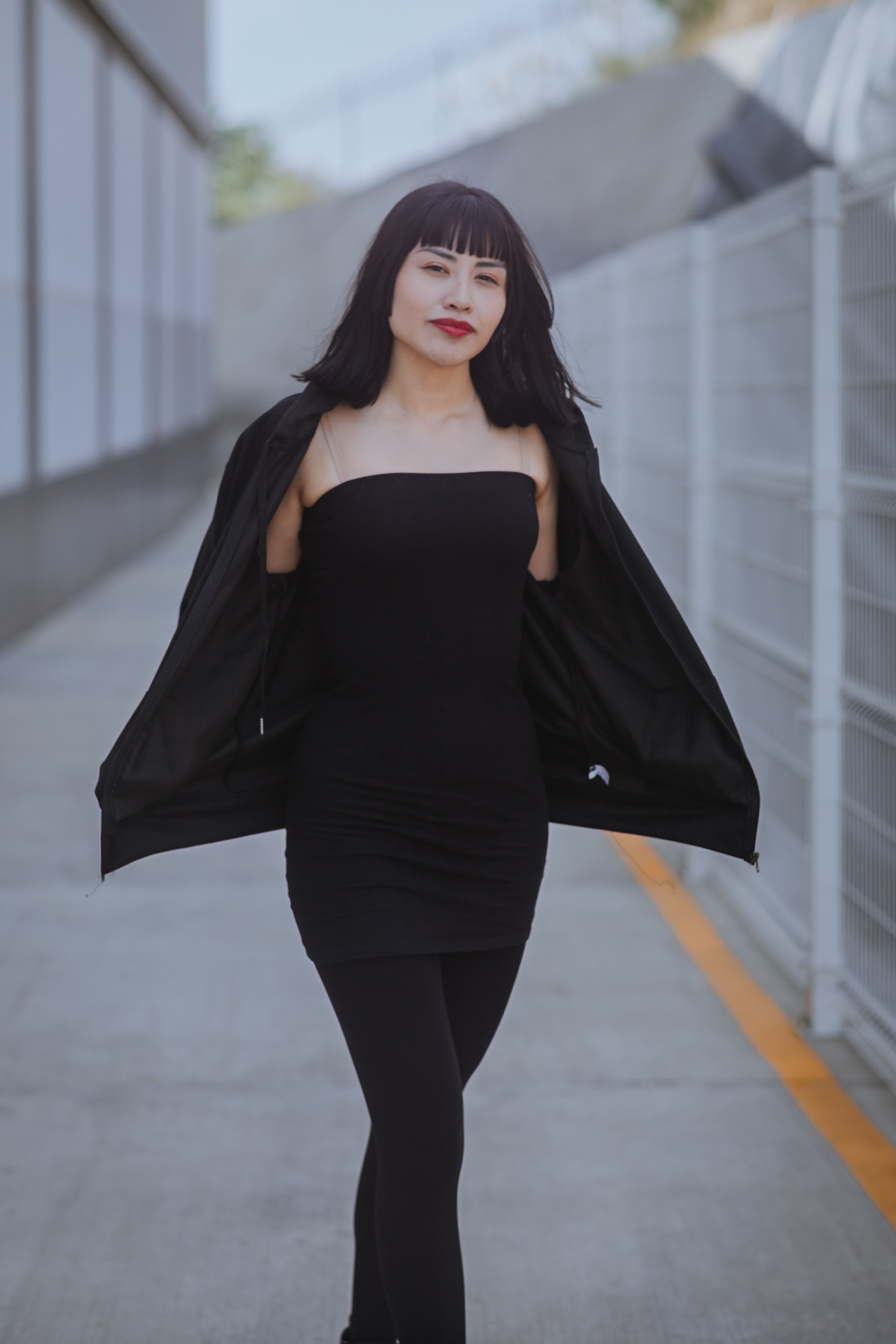 Stylish Woman Walking Outdoors in Black Outfit · Free Stock Photo