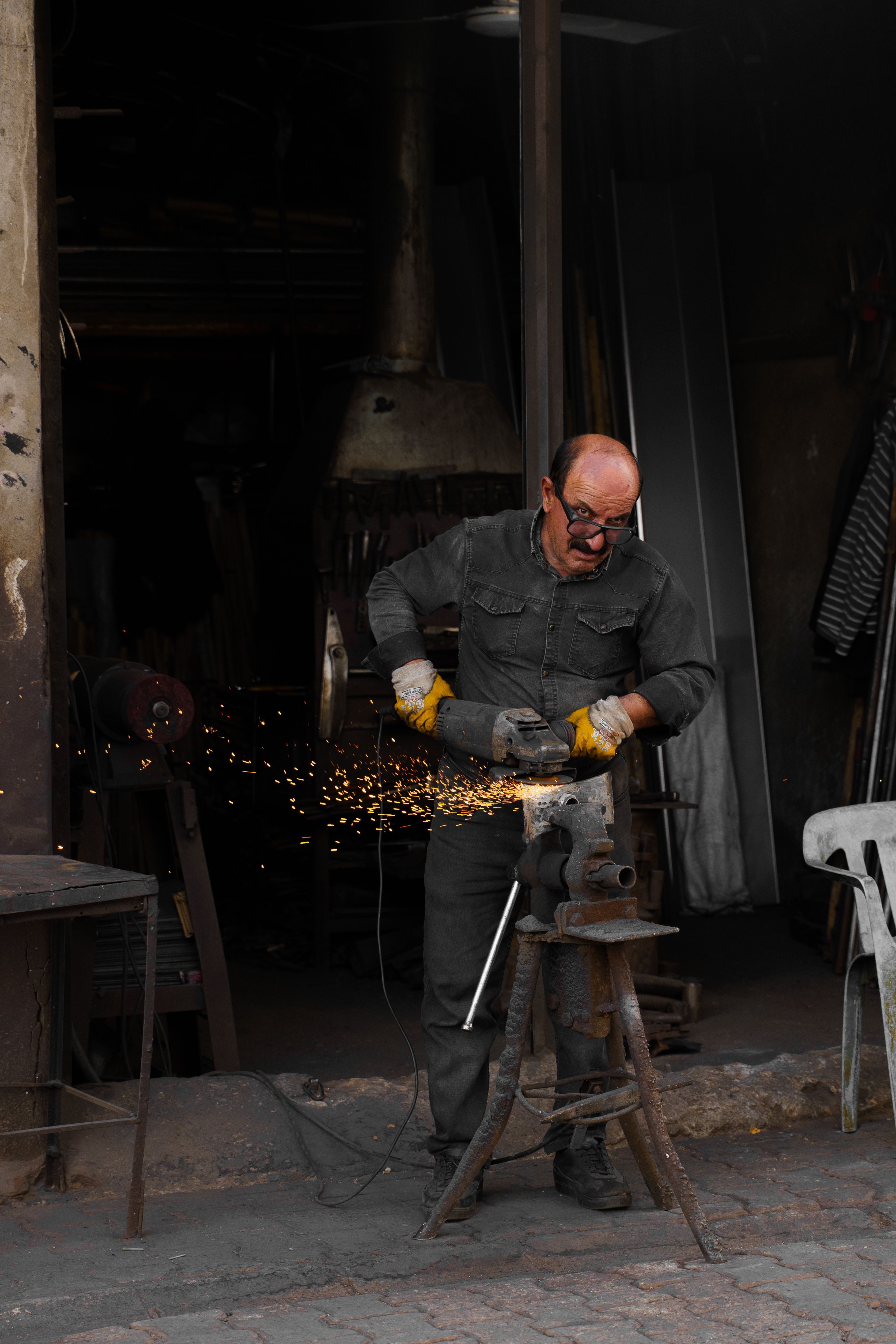 Skilled Turkish Blacksmith Working in Workshop · Free Stock Photo